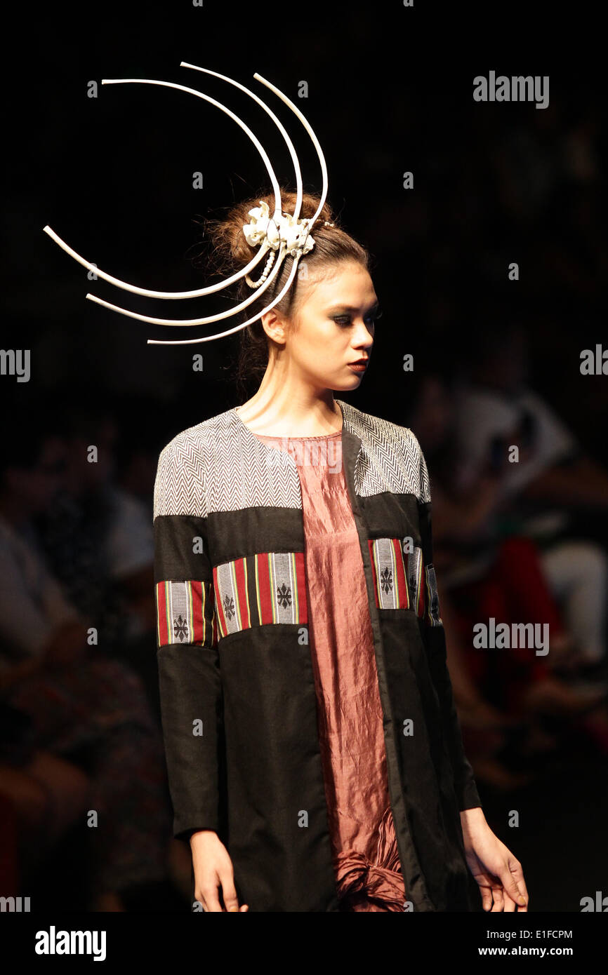 A model presents a creation of Happy Andrada during the Philippine ...