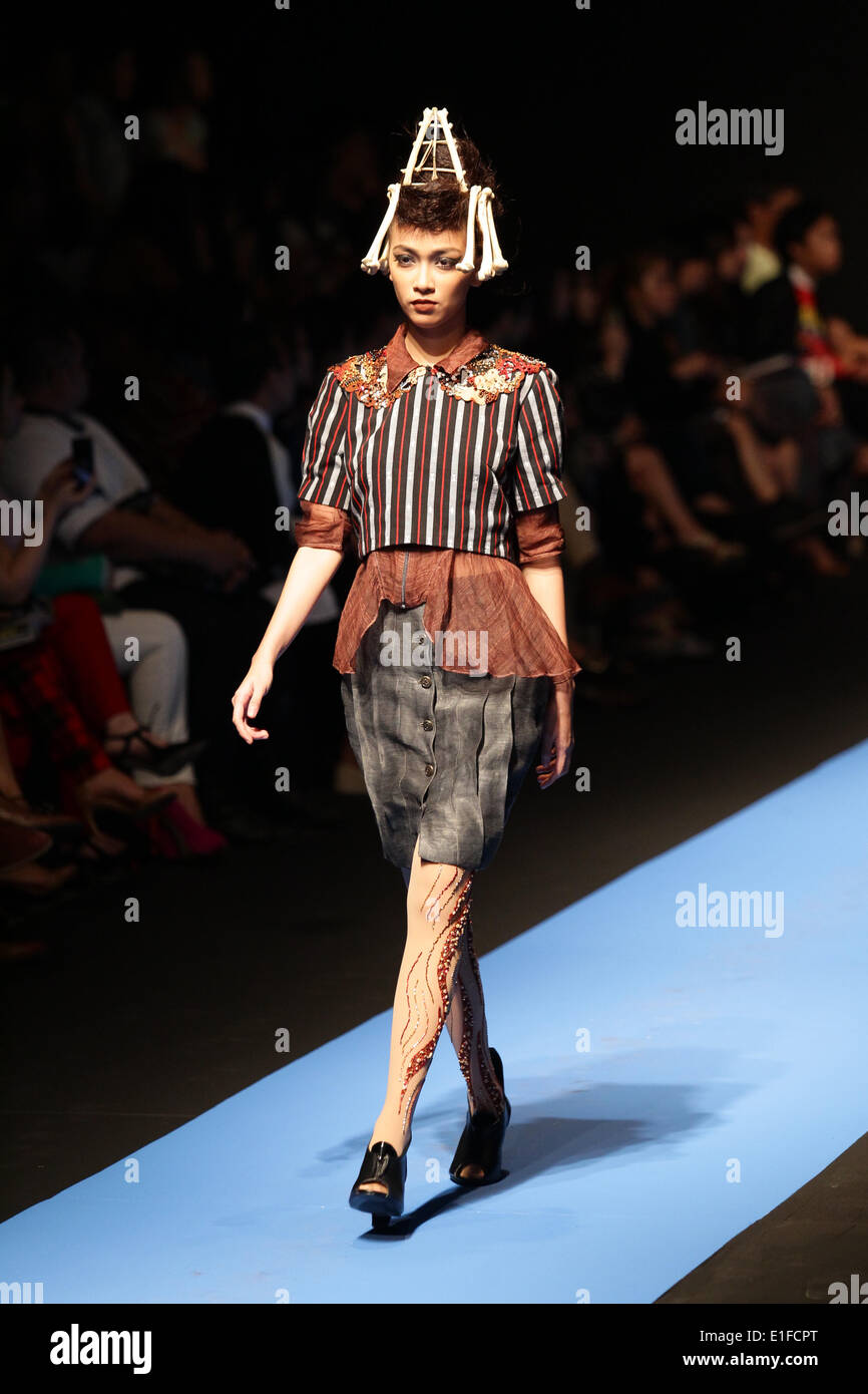 A model presents a creation of Happy Andrada during the Philippine ...