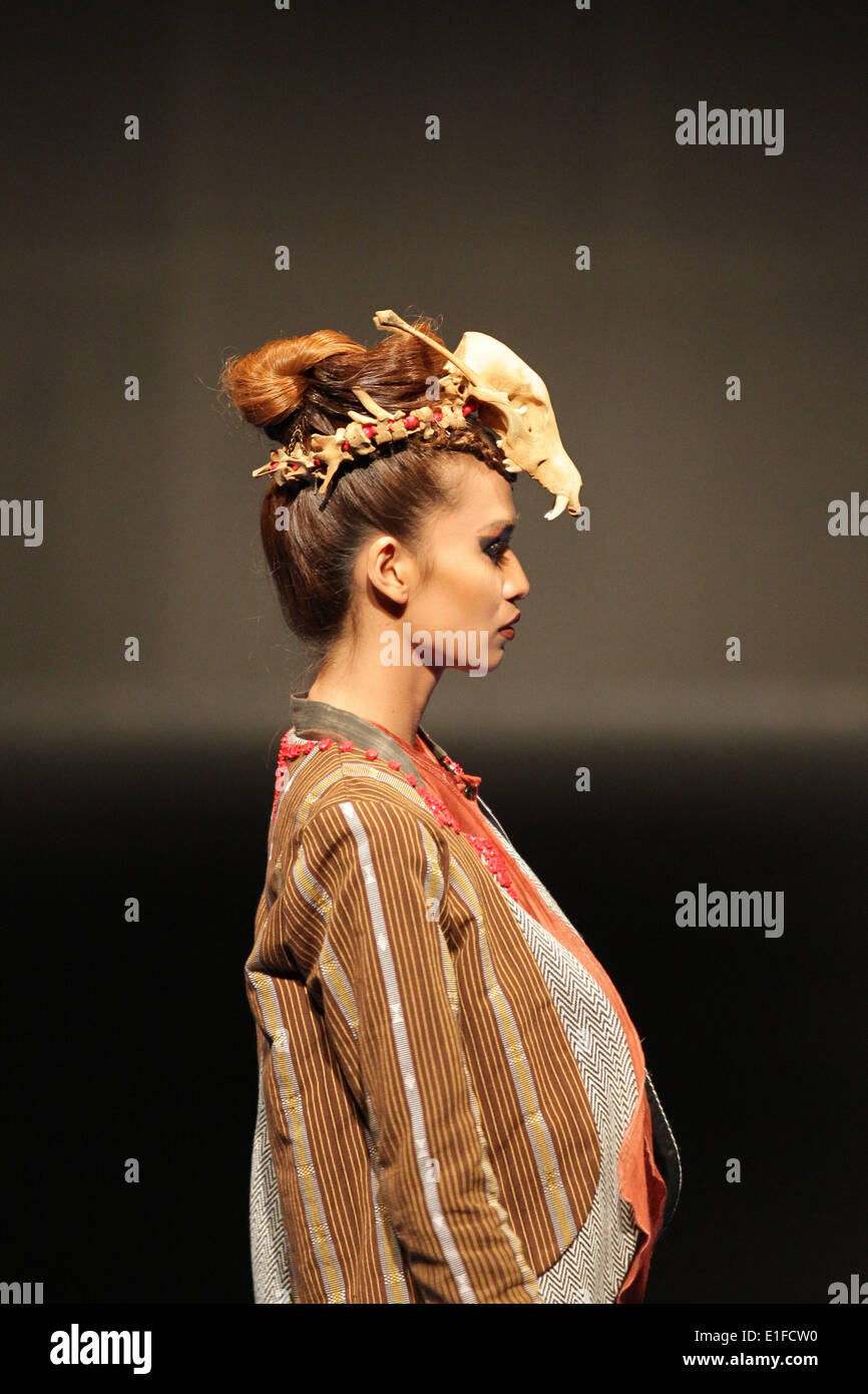 A model presents a creation of Happy Andrada during the Philippine ...