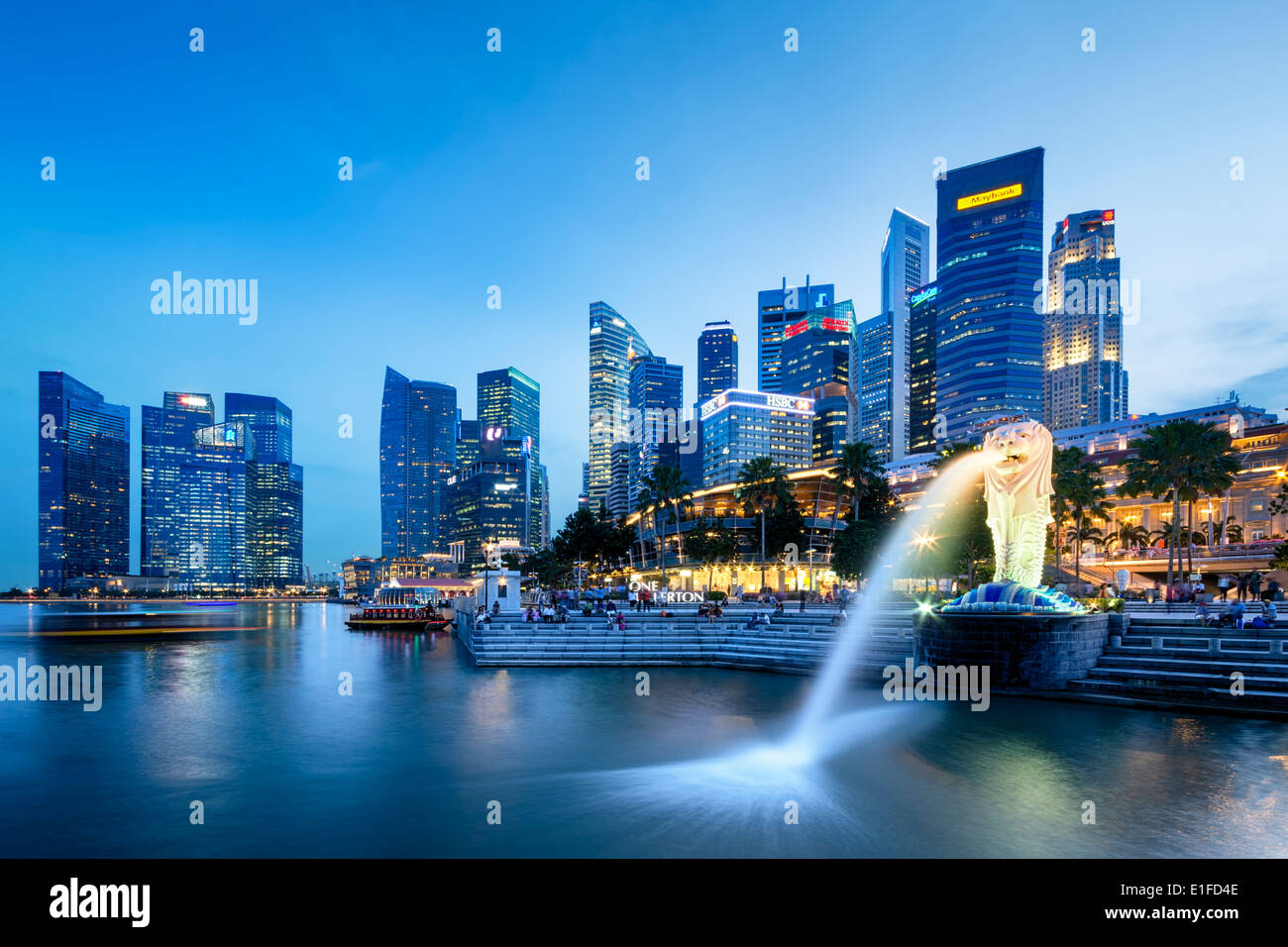 Tourist gathering at the Merlion in Singapore. Merlion is a central ...