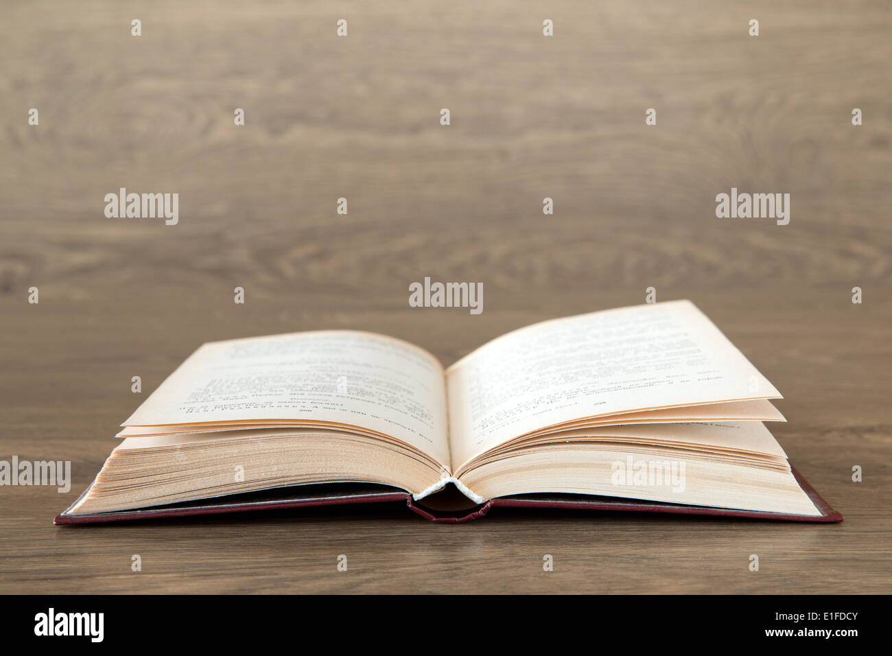 Open book on wood background Stock Photo - Alamy