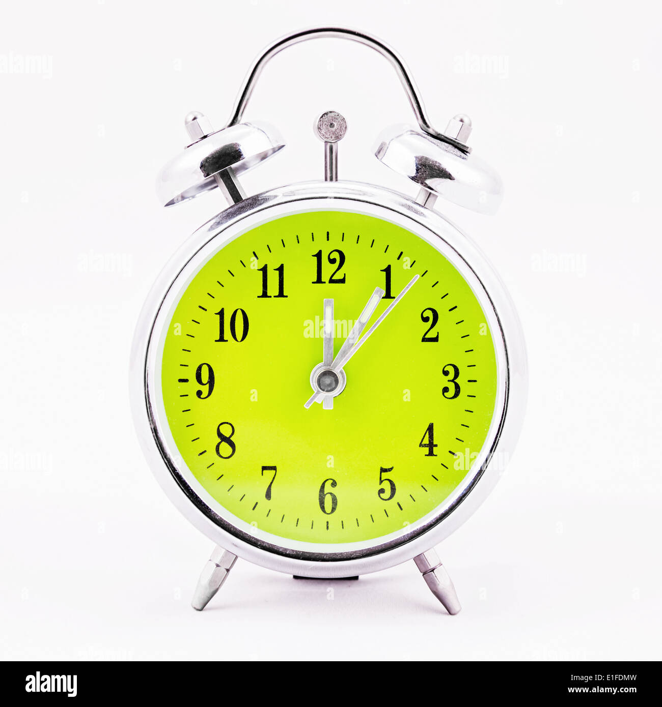 Alarm clock on white background. Showing time five minutes past twelve ...