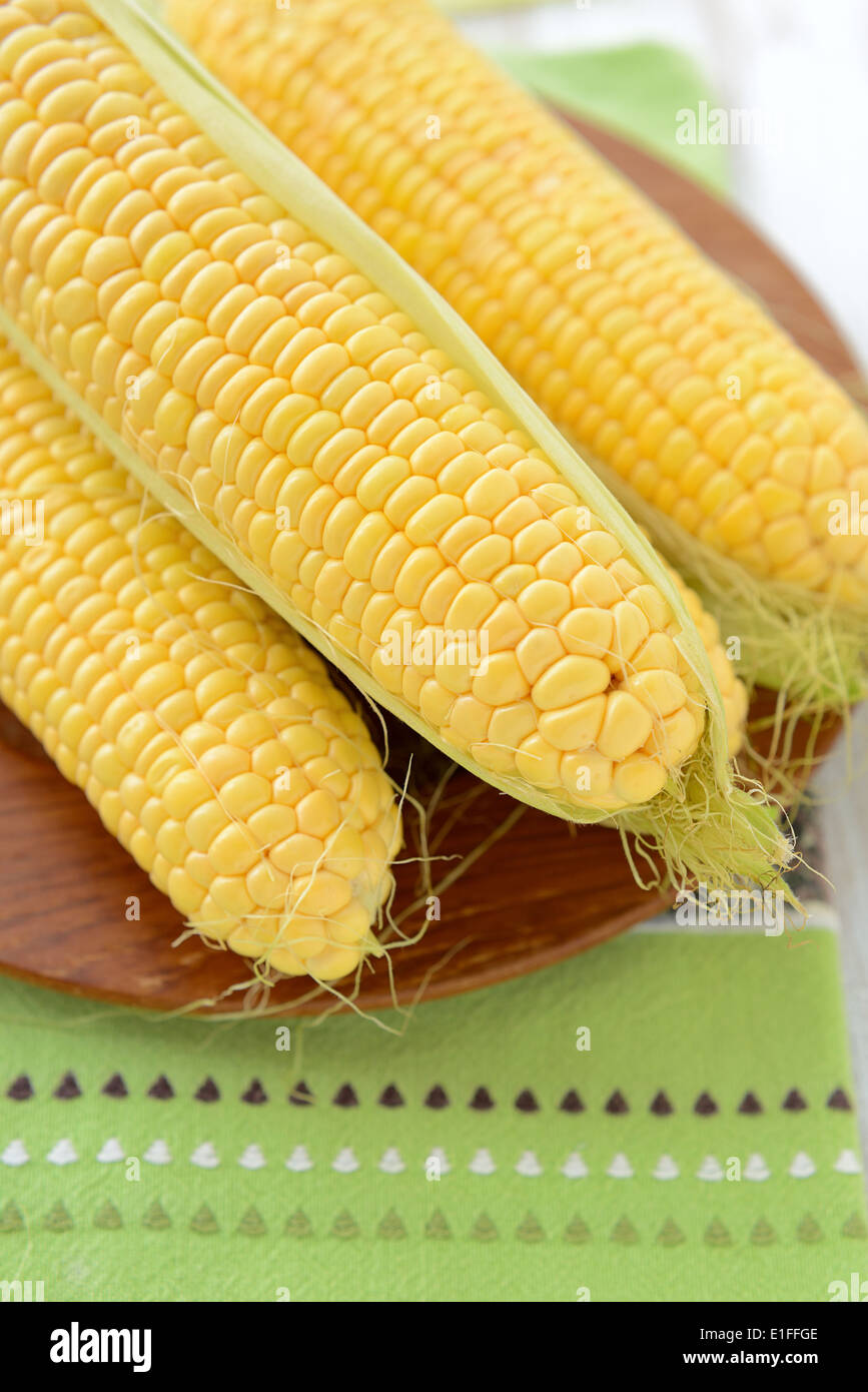 Three cobs on a green background Stock Photo - Alamy