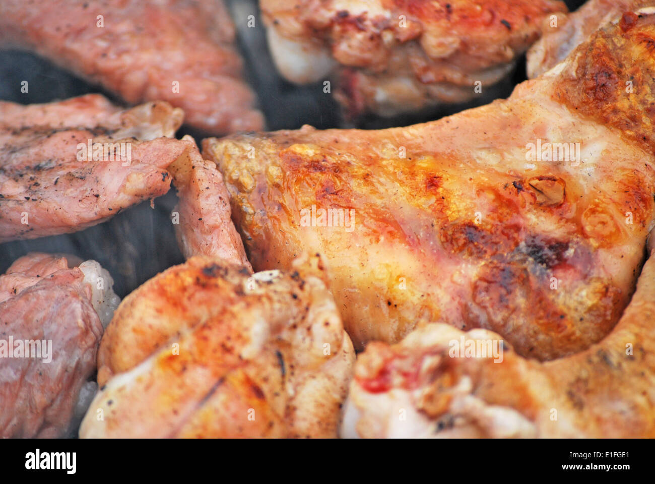 Fried meat on grill Stock Photo - Alamy