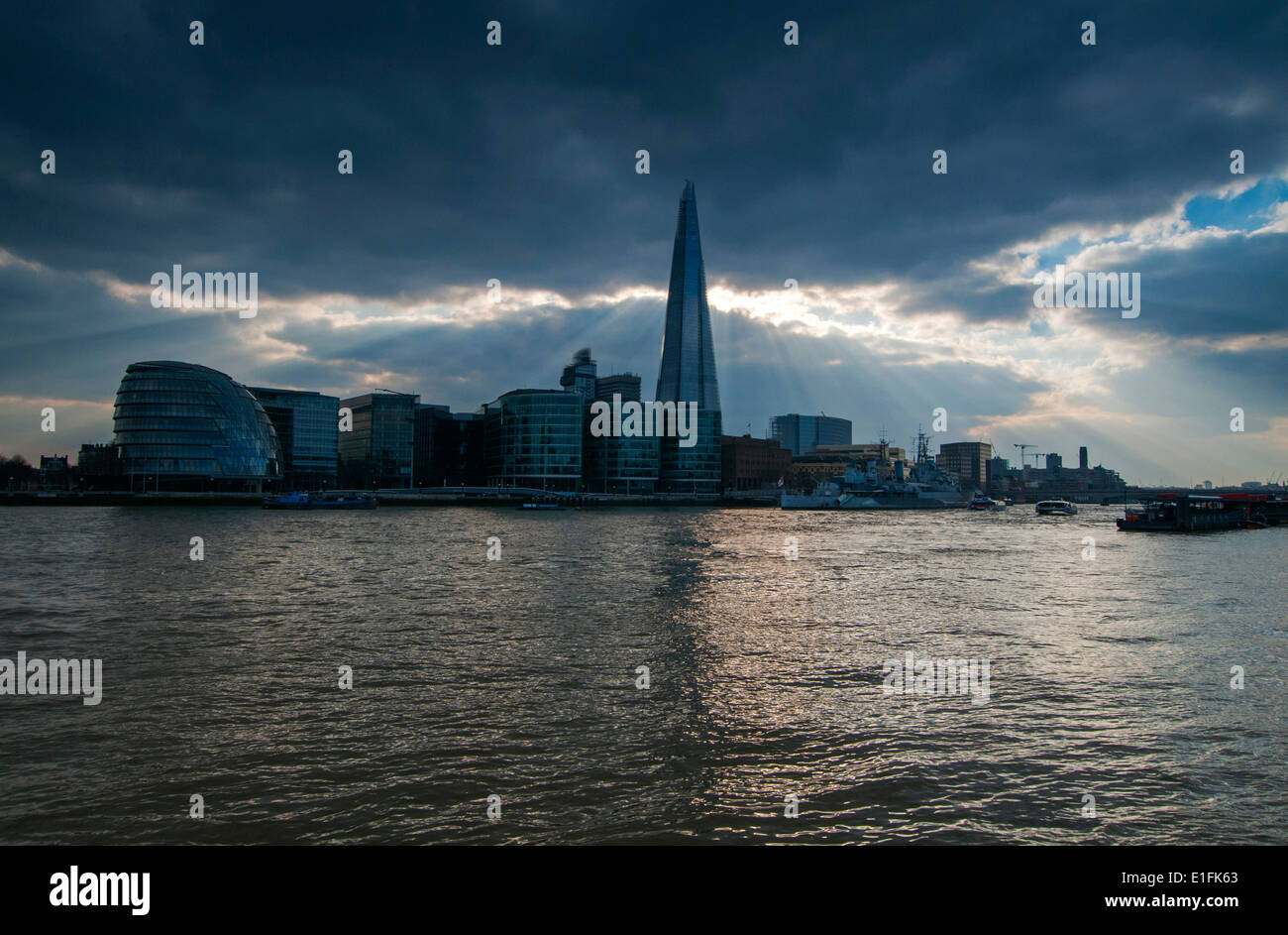 Stormy skies and rays of light shine over the city skyline in London ...