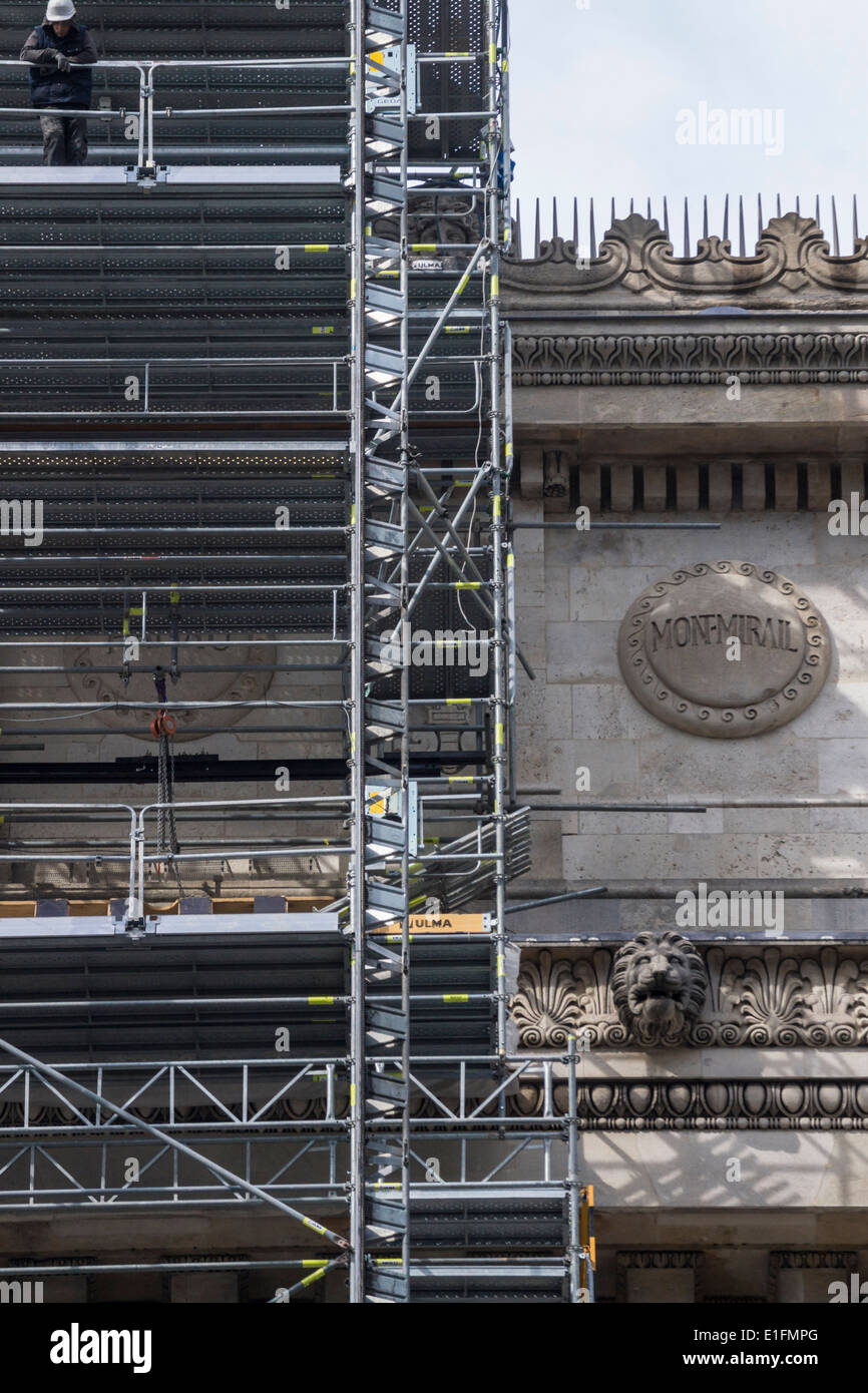 Paris, France. A construction worker stands on a scaffolding at the Arc ...