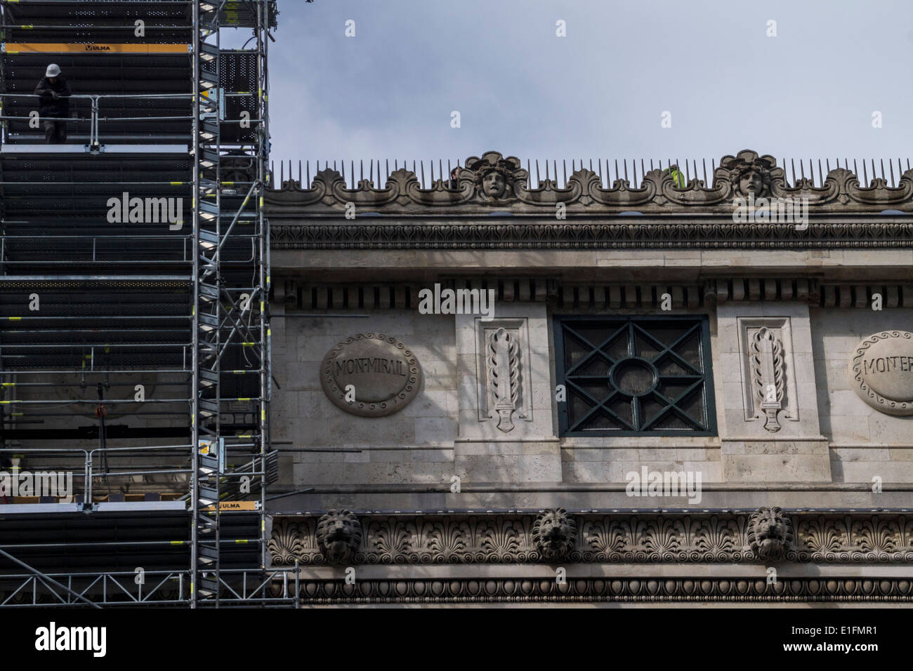 Paris, France. A construction worker stands on a scaffolding at the Arc ...
