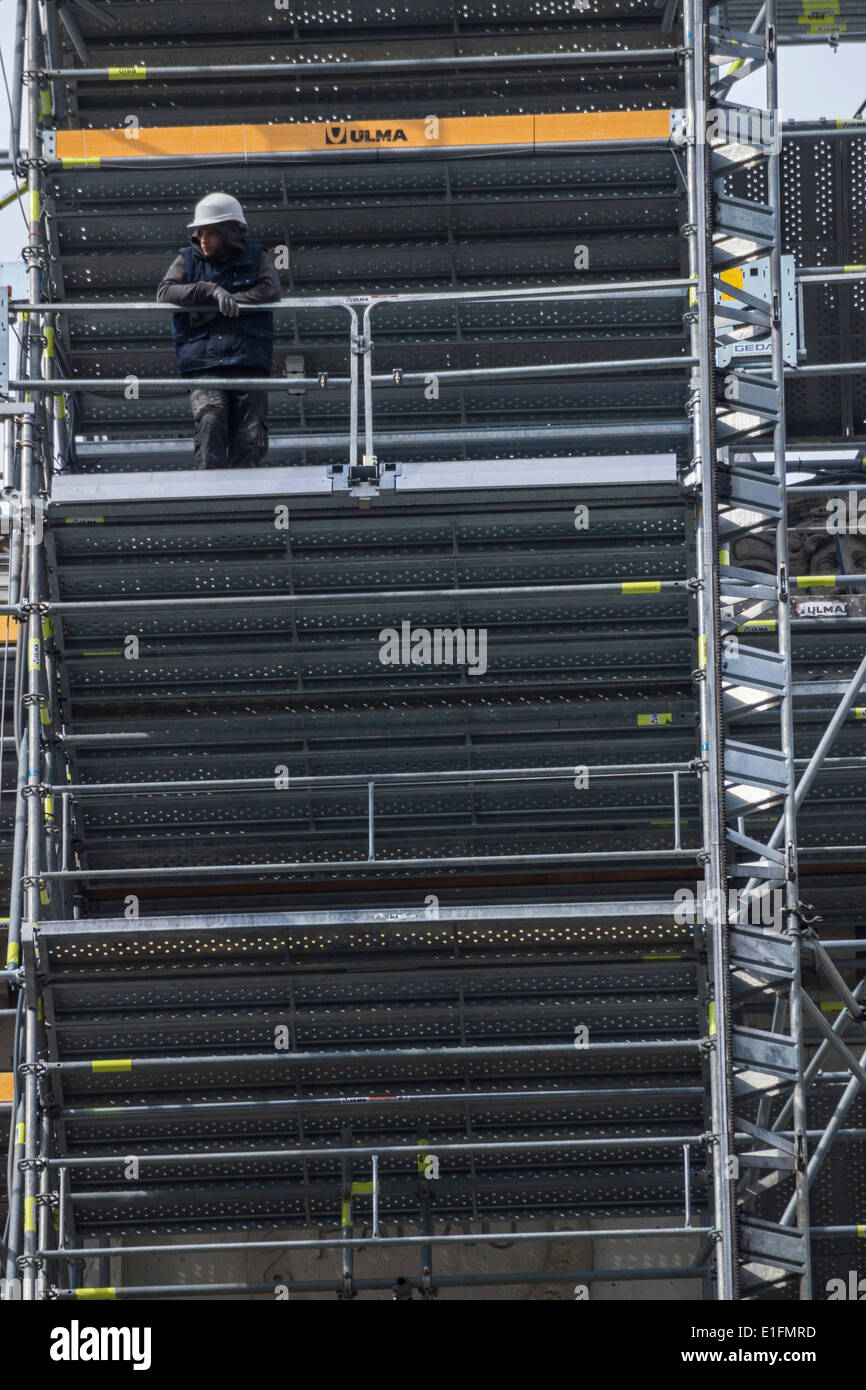 Paris, France. A construction worker stands on a scaffolding at the Arc ...