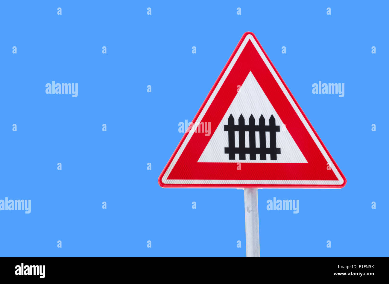 isolated traffic sign approaching a railroad secured with automatic ...
