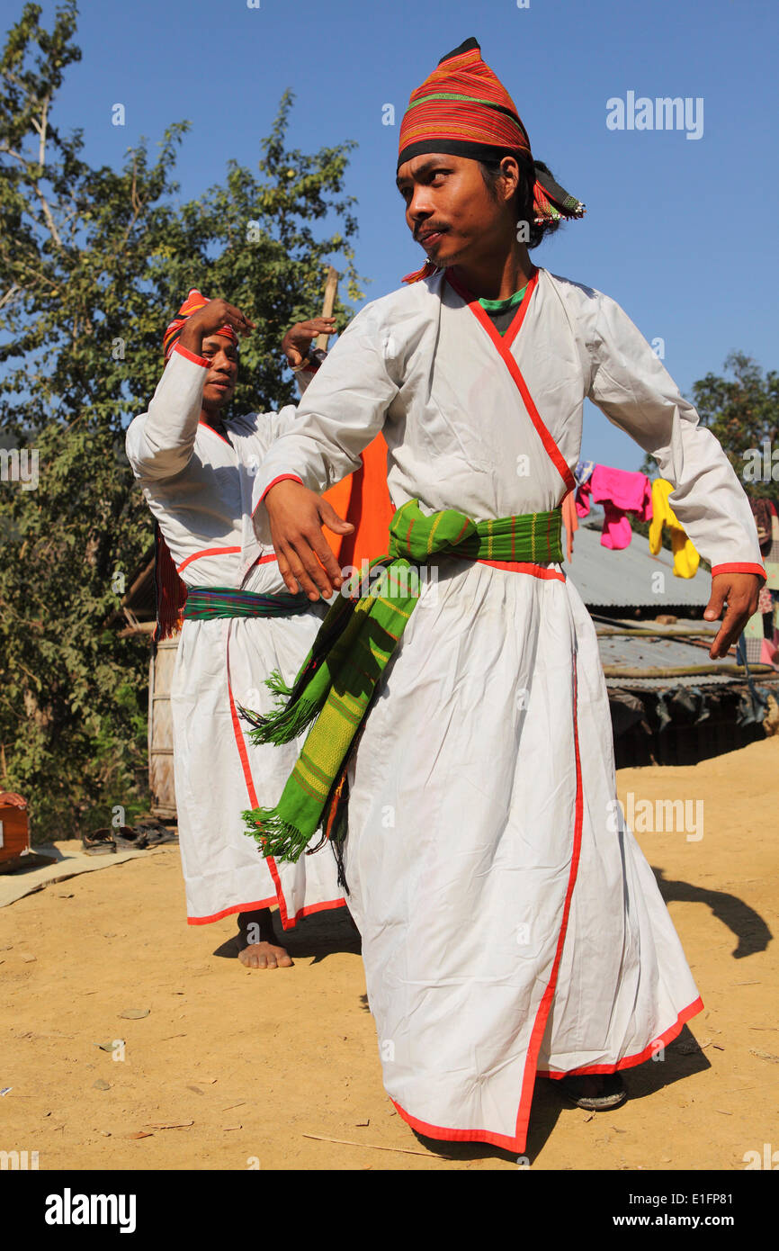Tripura tribesmen performing a traditional dance wearing robes, in ...