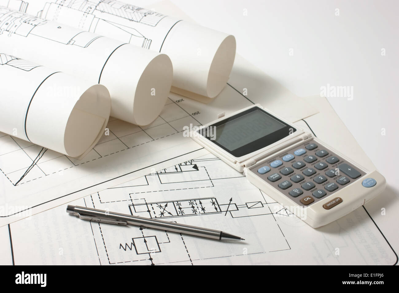 rolled technical drawings and a calculator Stock Photo - Alamy