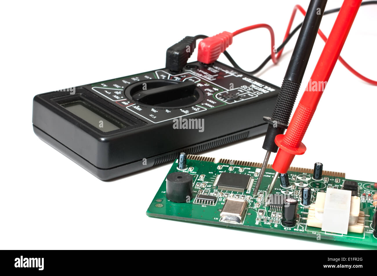 electronic boards and digital multimeter isolated on a white background ...