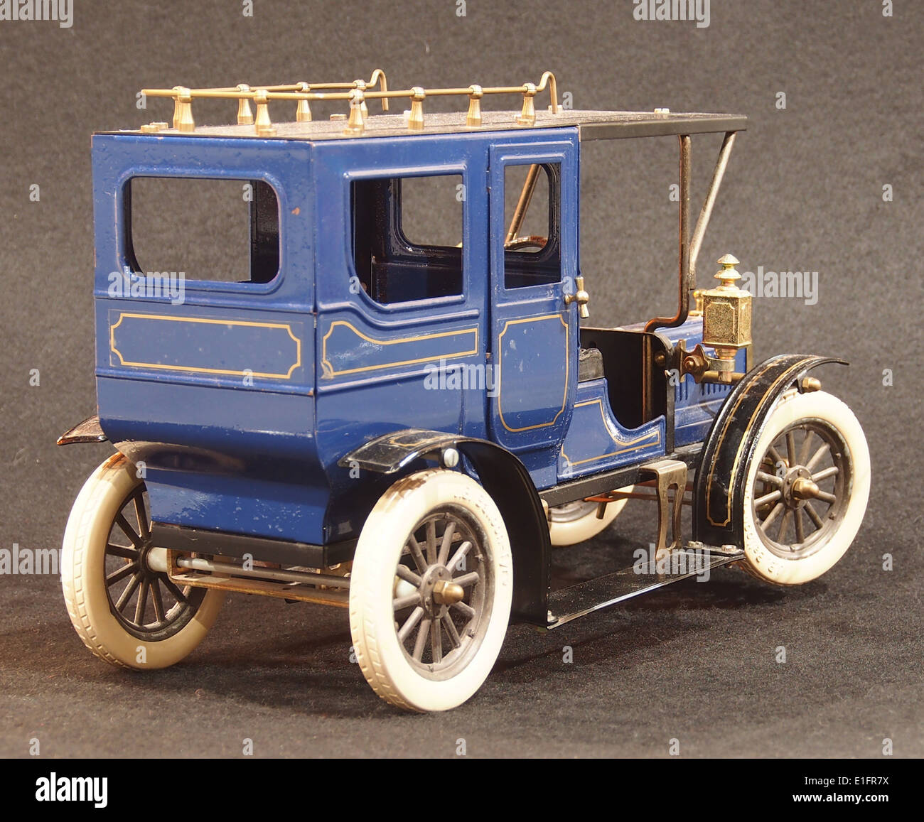 This image features a collectible tin car with balloon tyres. The tin ...