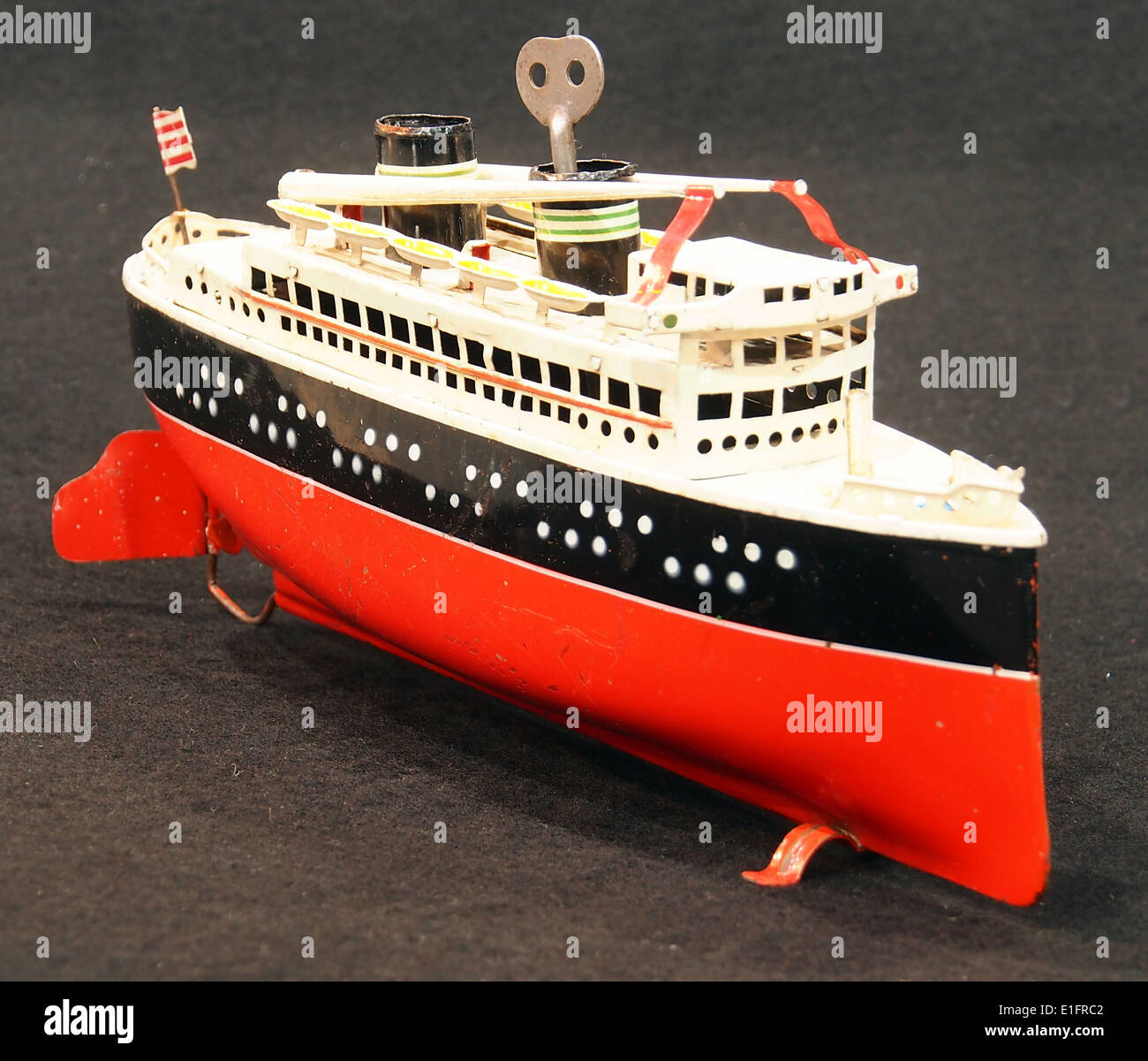 An old tin toy clockwork ship, representing the early era of mechanical ...