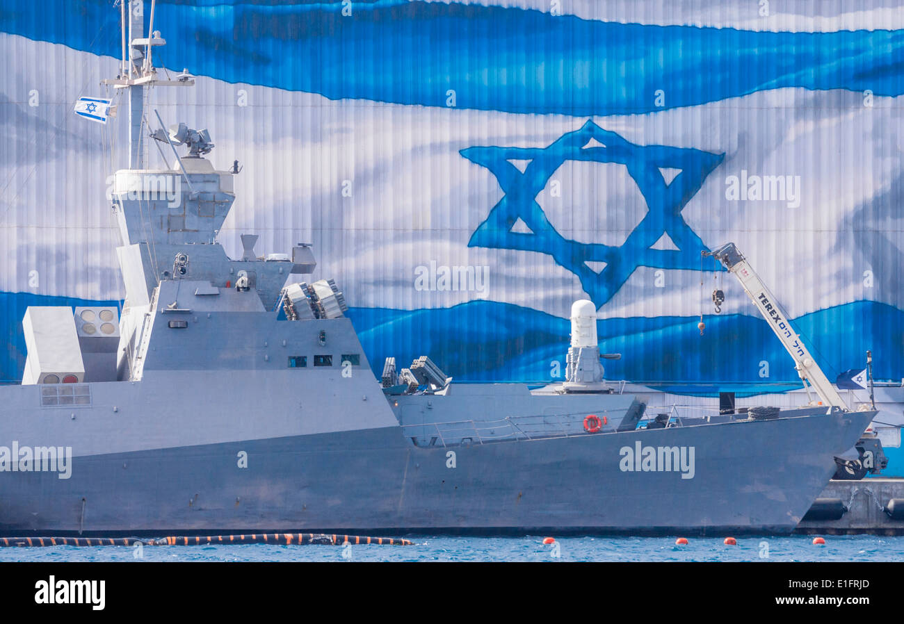 Eilat. A "Saar 5" missile frigate anchored along a large Israeli flag ...