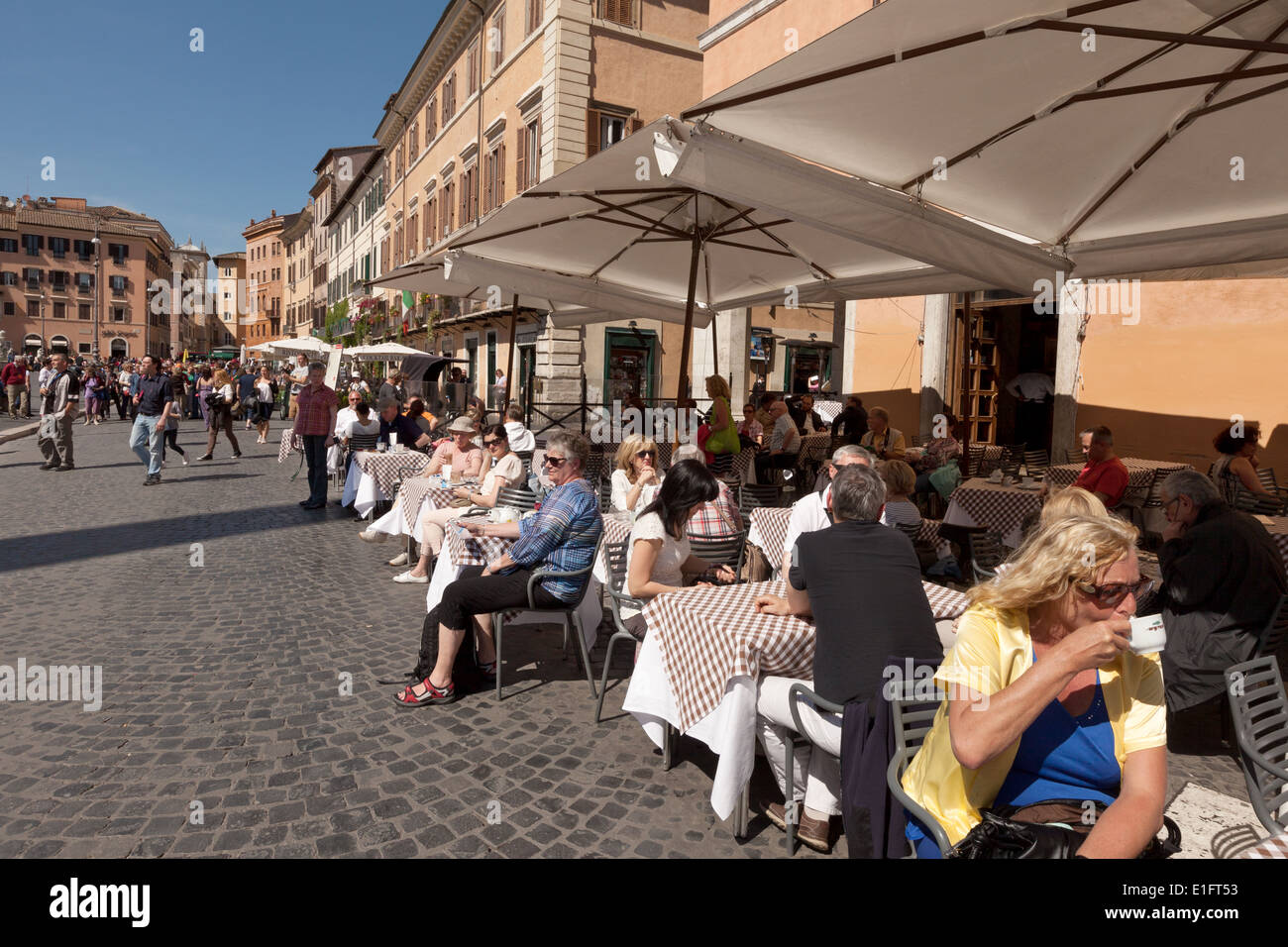 Piazza Navona, people eating at a cafe restaurant on its eastern side ...