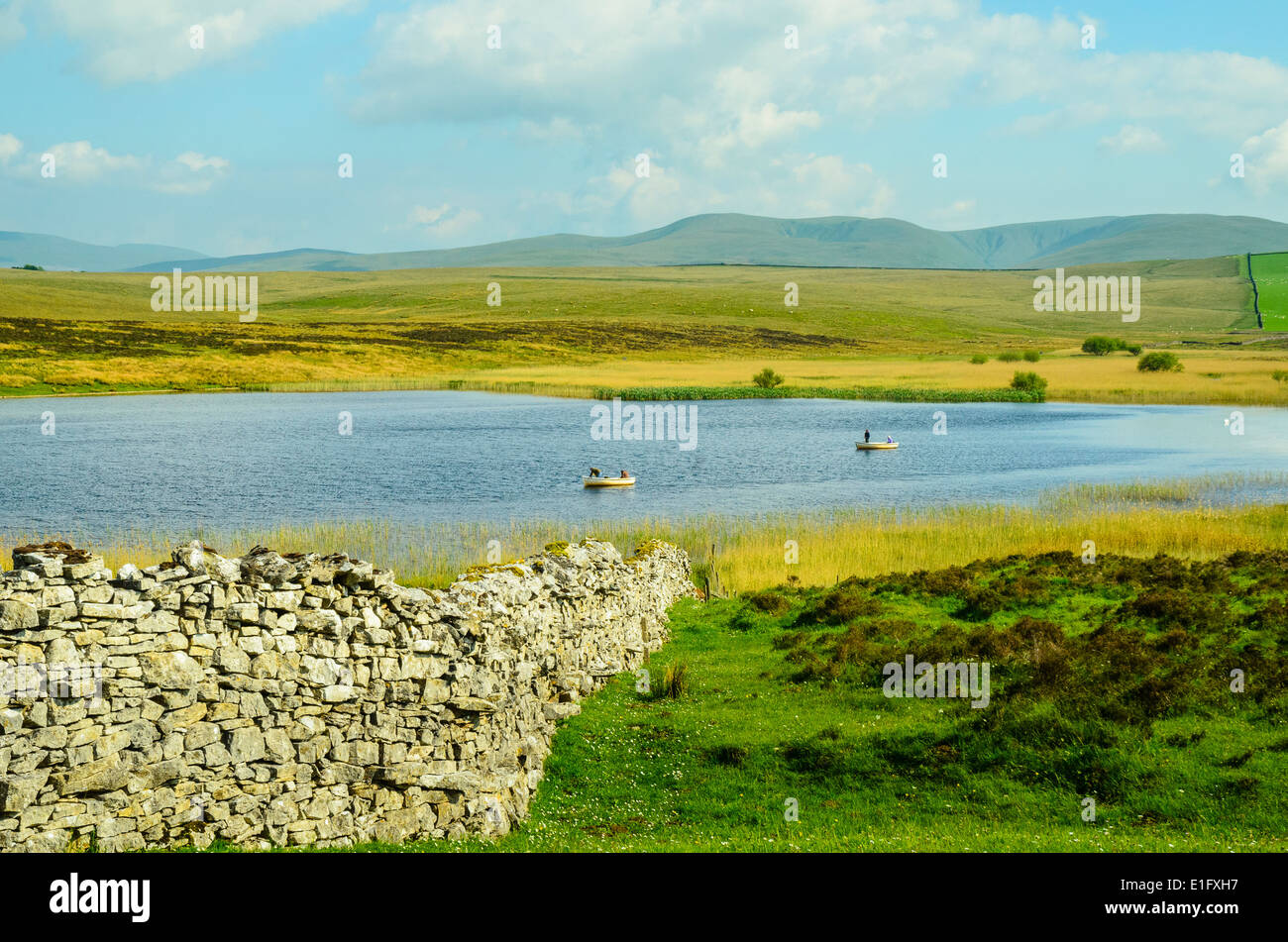 Anglers on Sunbiggin Tarn in the upper Lune valley Cumbria with the ...