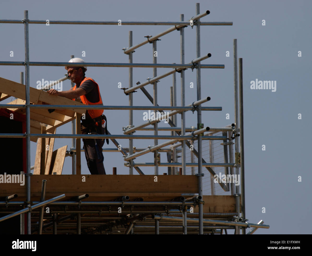 Workman on roof hi-res stock photography and images - Alamy