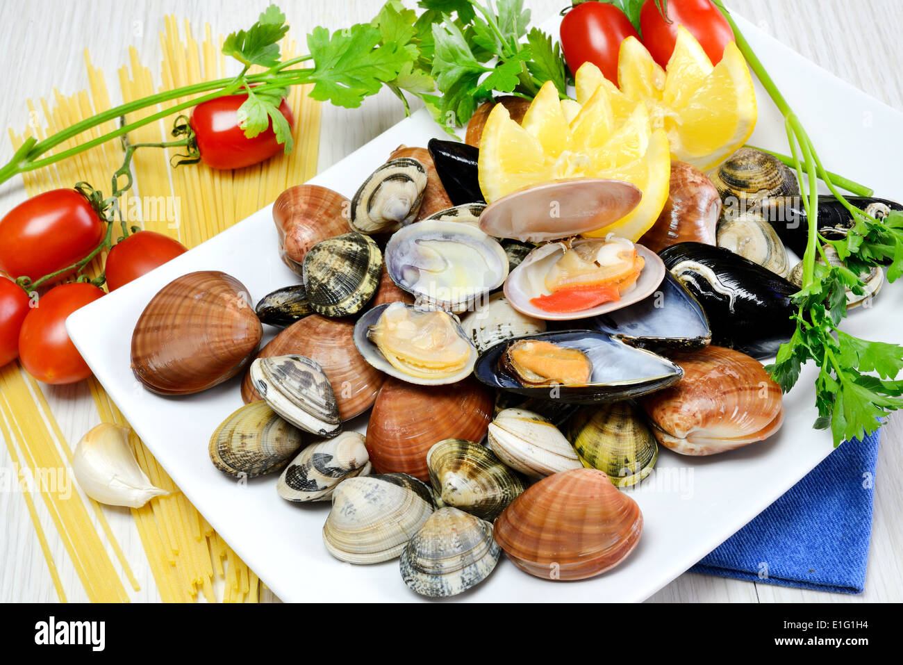 raw sea fruits called fasolari live again with lemon and spaghetti ...