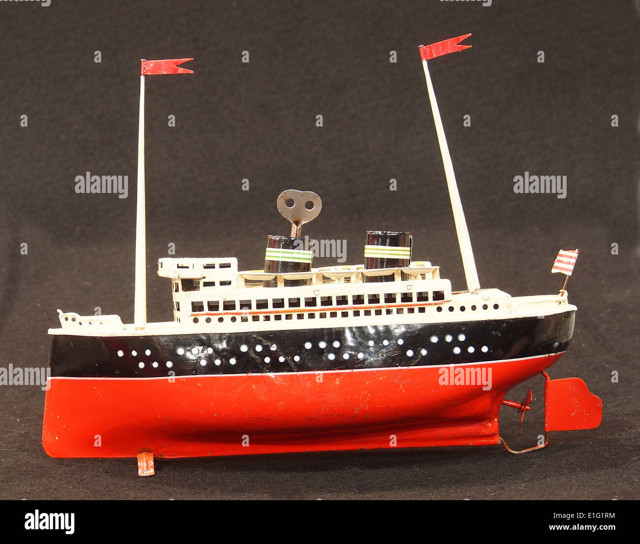 A vintage tin toy ship powered by a clockwork mechanism. The toy ship ...