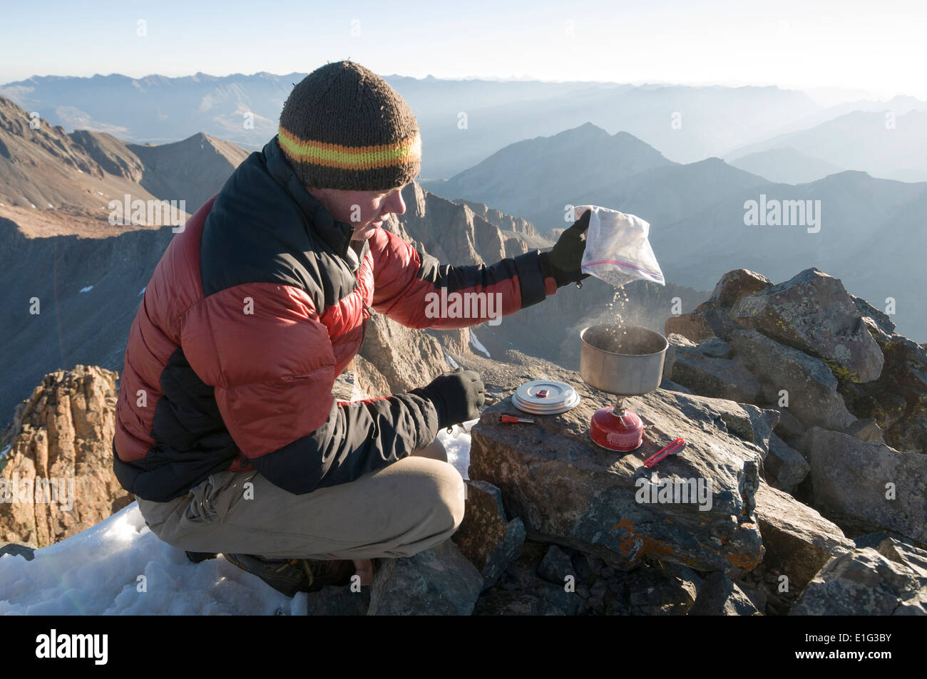 A man boiling water on campstove on the summit of Mount Wilson near ...