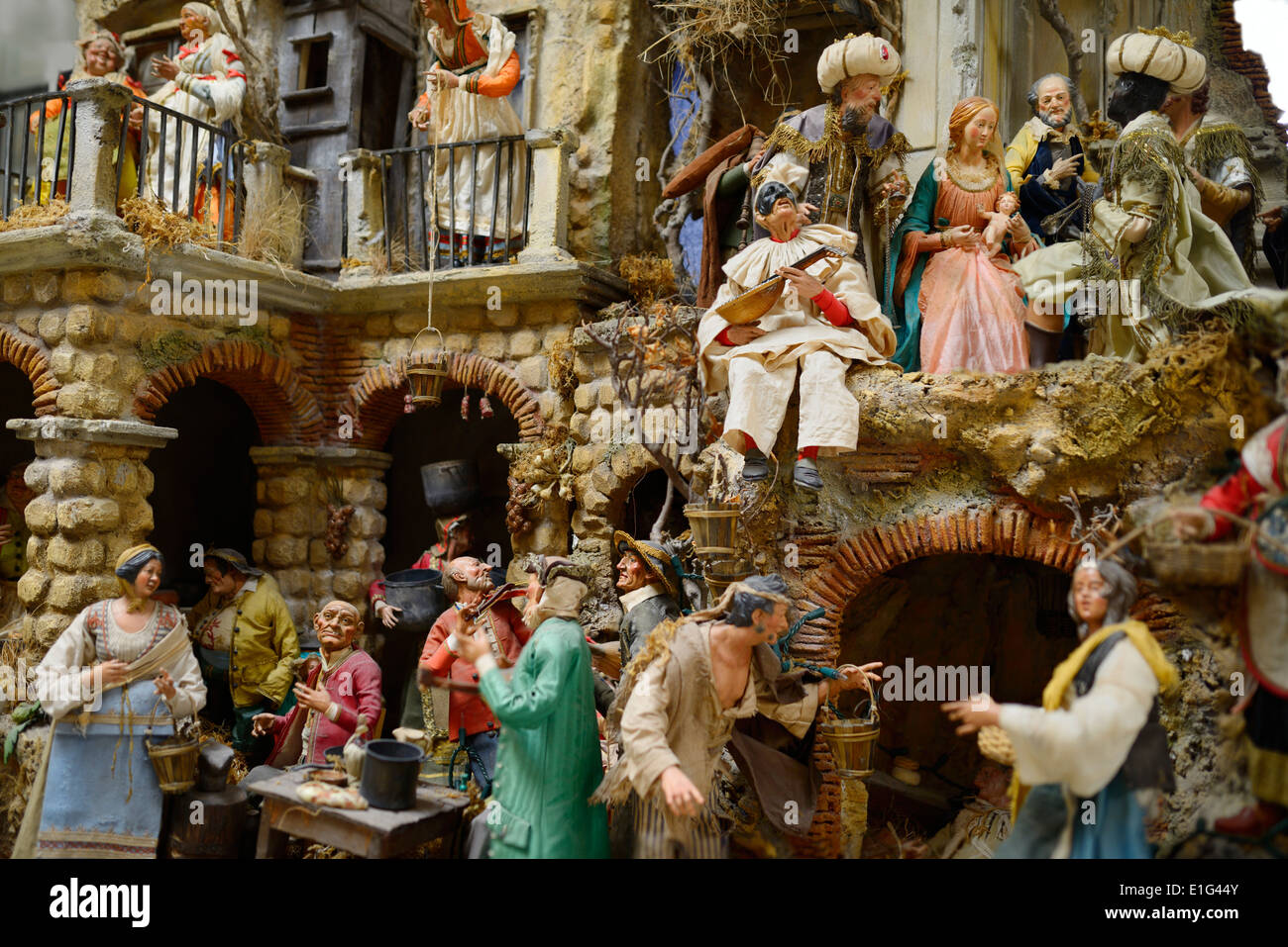 Whimsical creche scene of people in Bethlehem village including holy ...