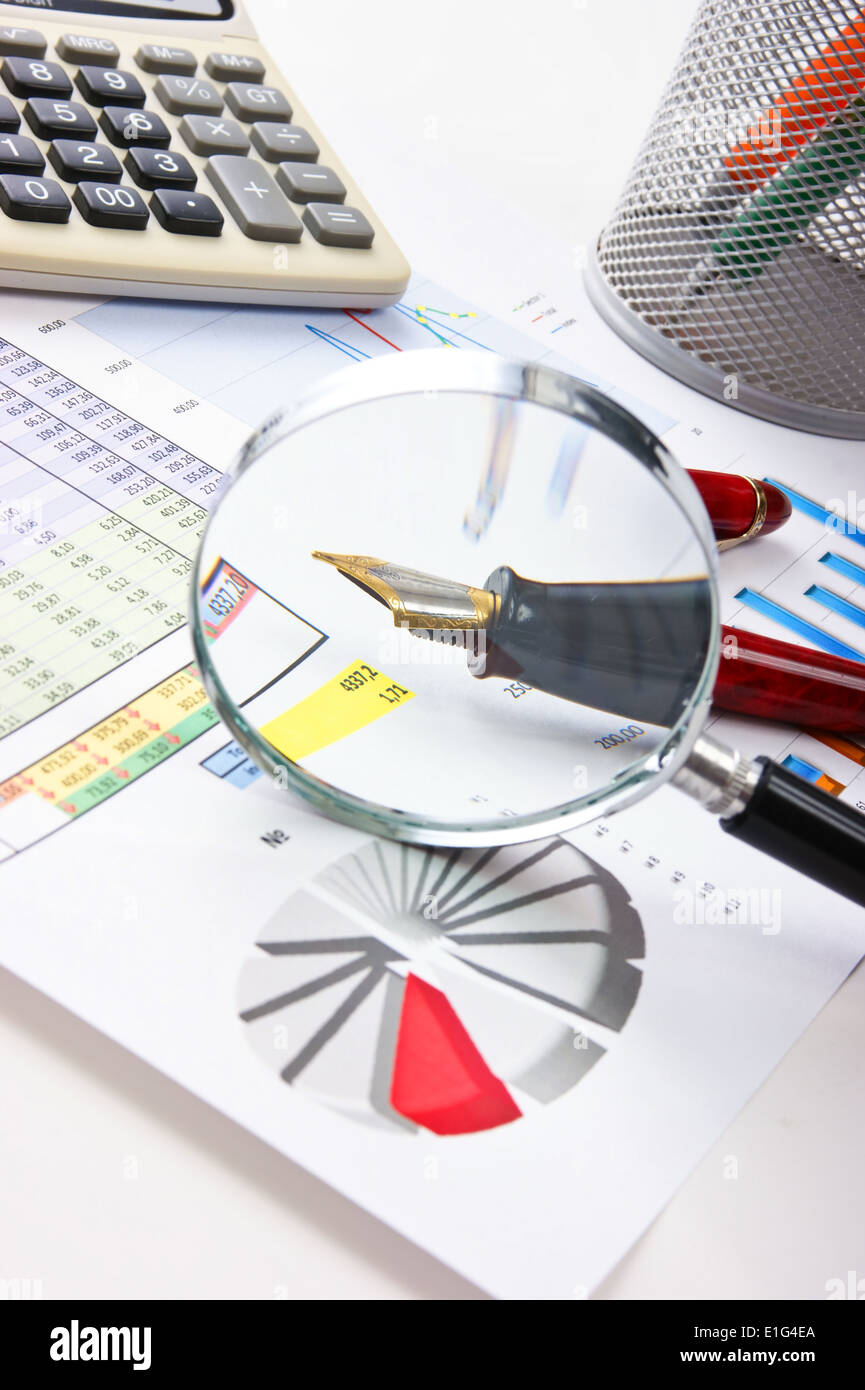 Magnifying glass and the working paper with a diagram hi-res stock ...