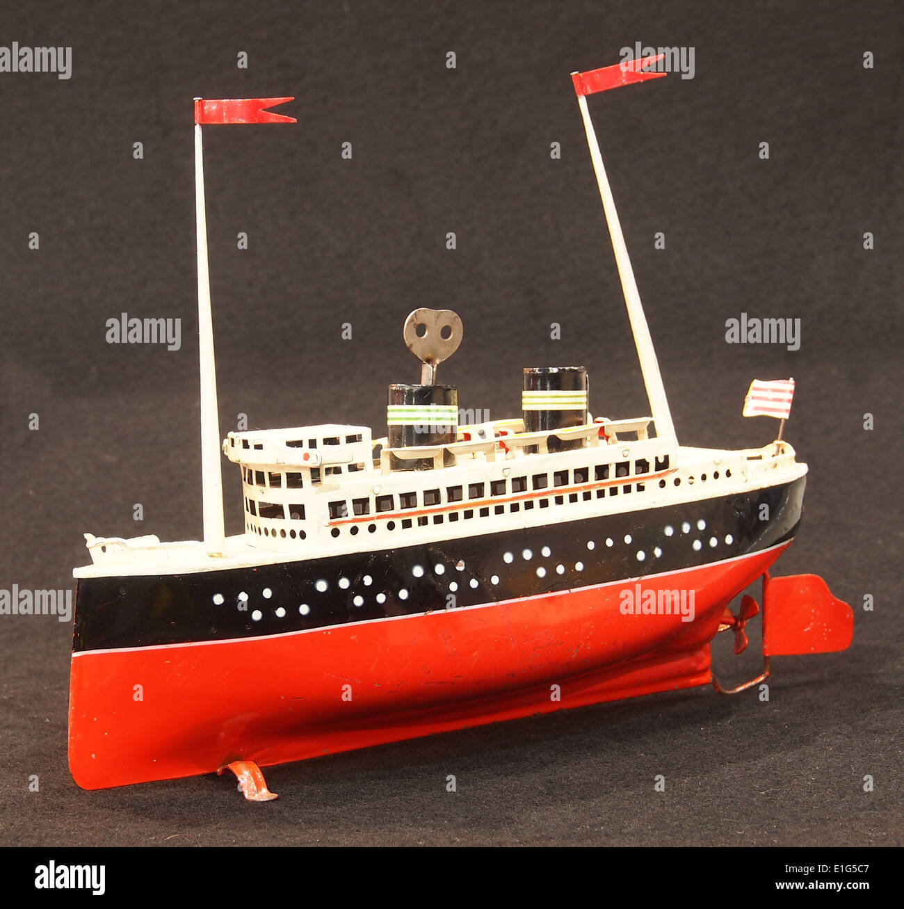 This image depicts a vintage tin toy clockwork ship, a mechanical toy ...