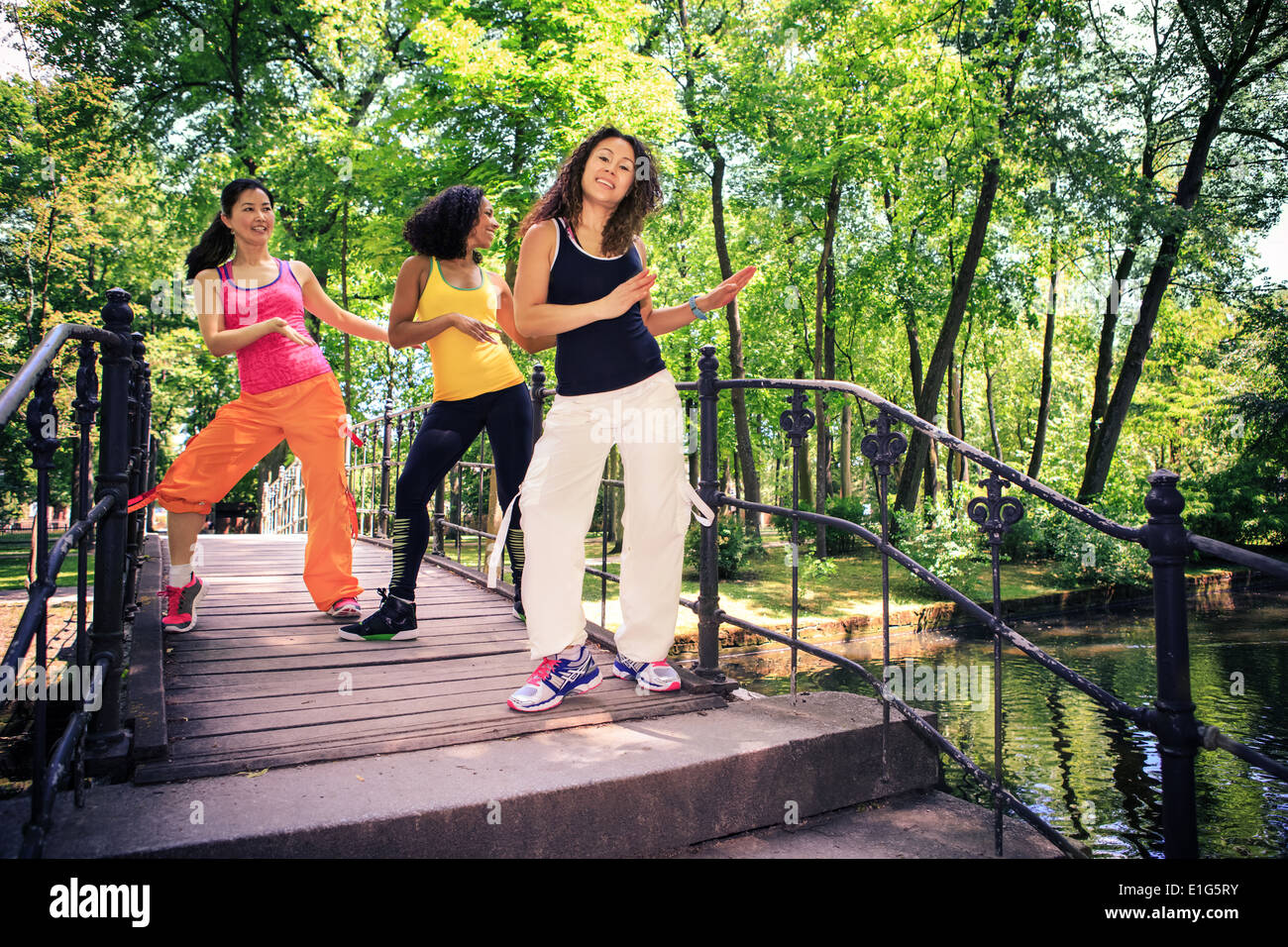 a group of women dancing the new fitness dance called zumba or aerobics ...