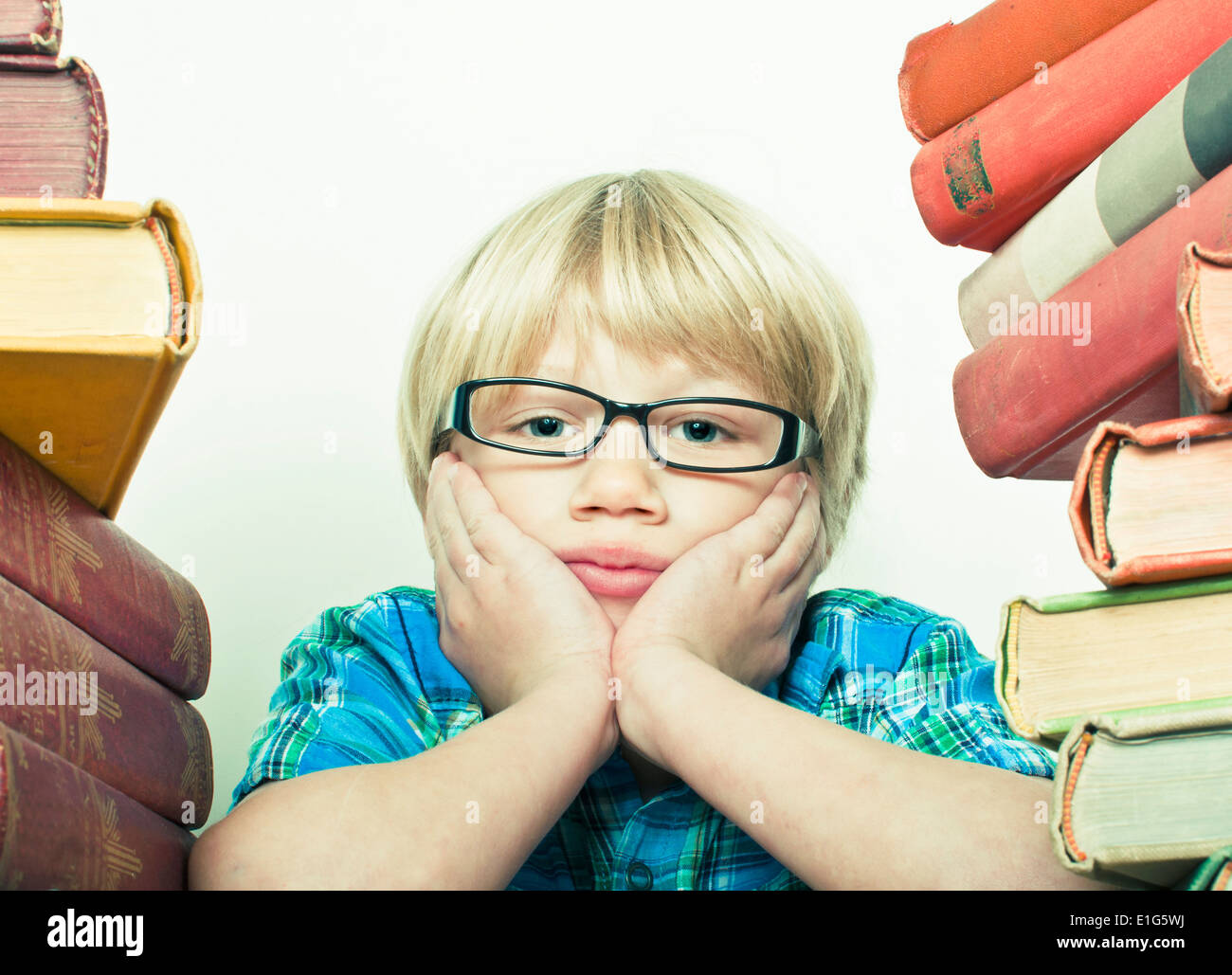 Little boy with too much homework Stock Photo - Alamy