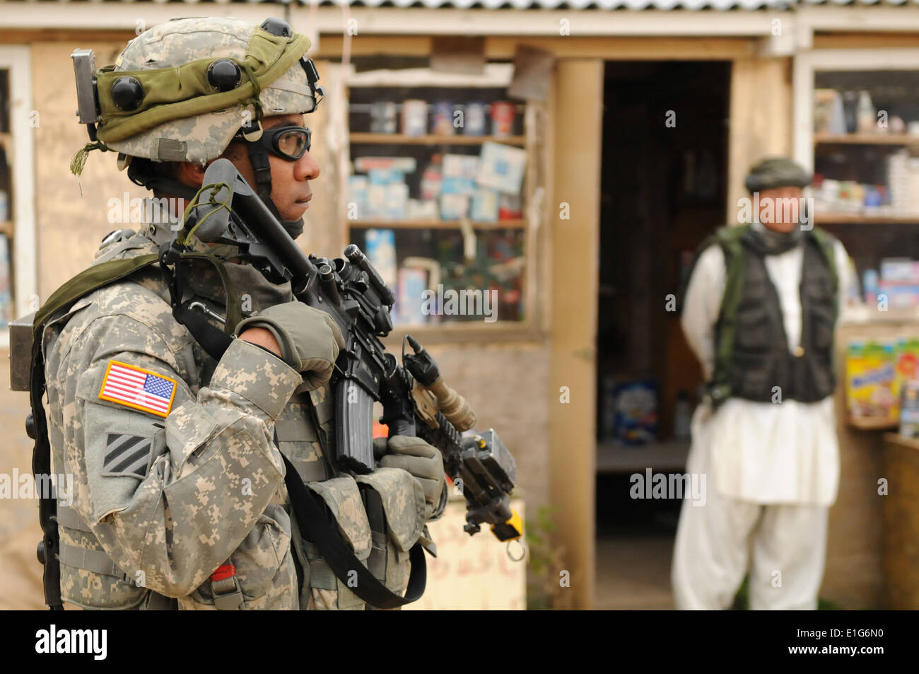 U.S. Army Sgt. Carl Williams, left, provides security for a presence ...