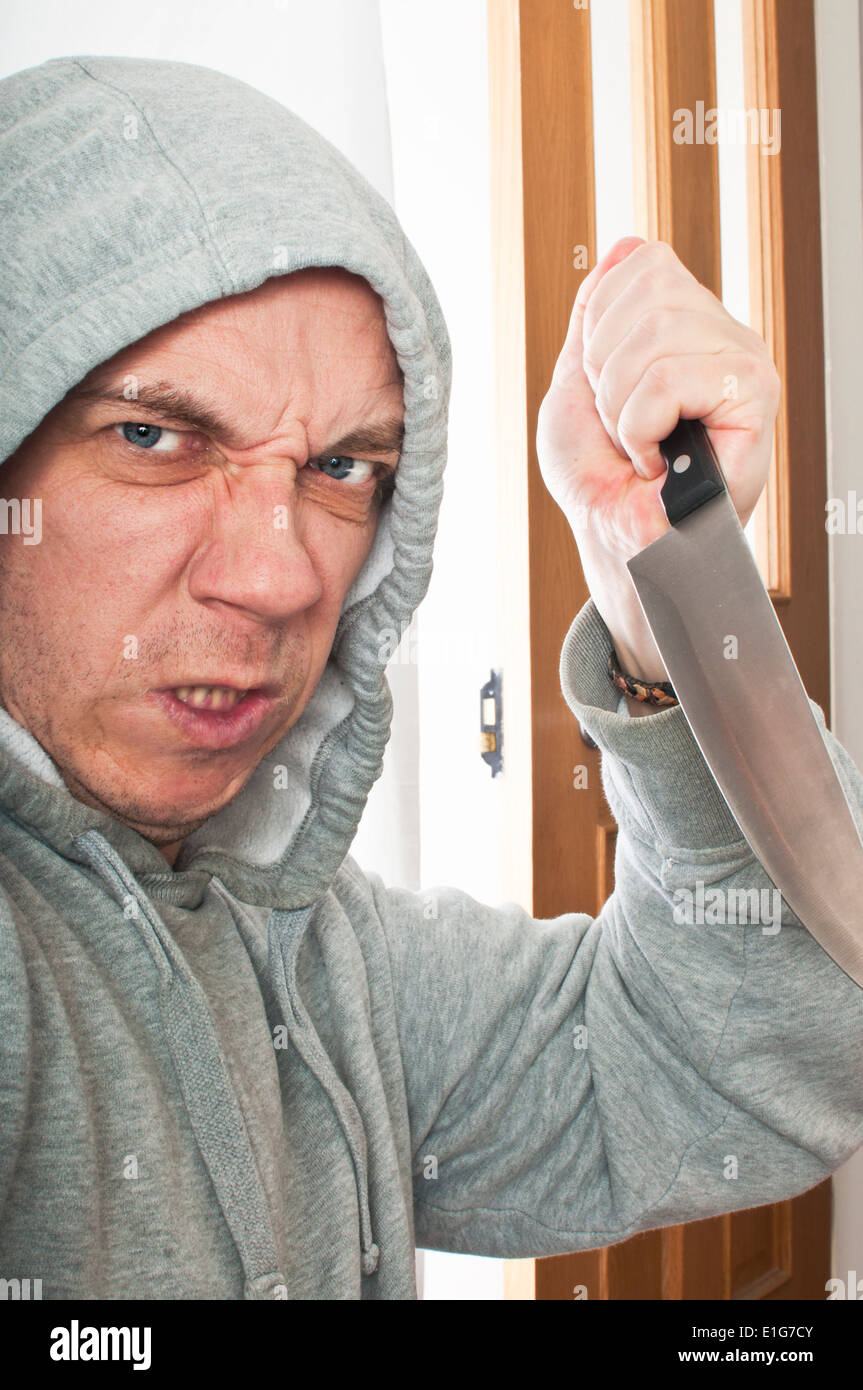 Violent intruder breaking into a house and confronting homeowner Stock ...
