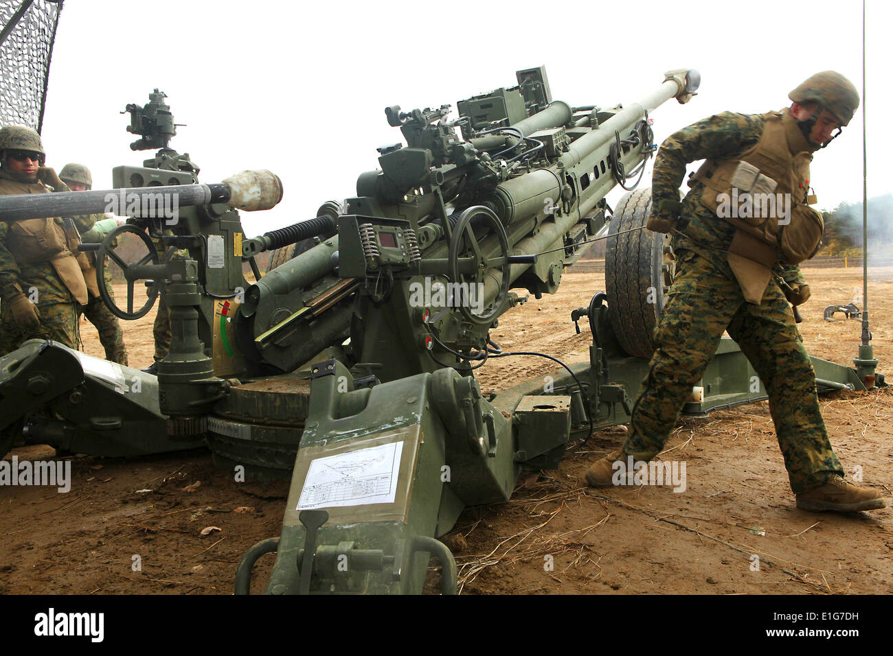 U.S. Marines fire a round from an M777A2 Lightweight 155 mm howitzer ...