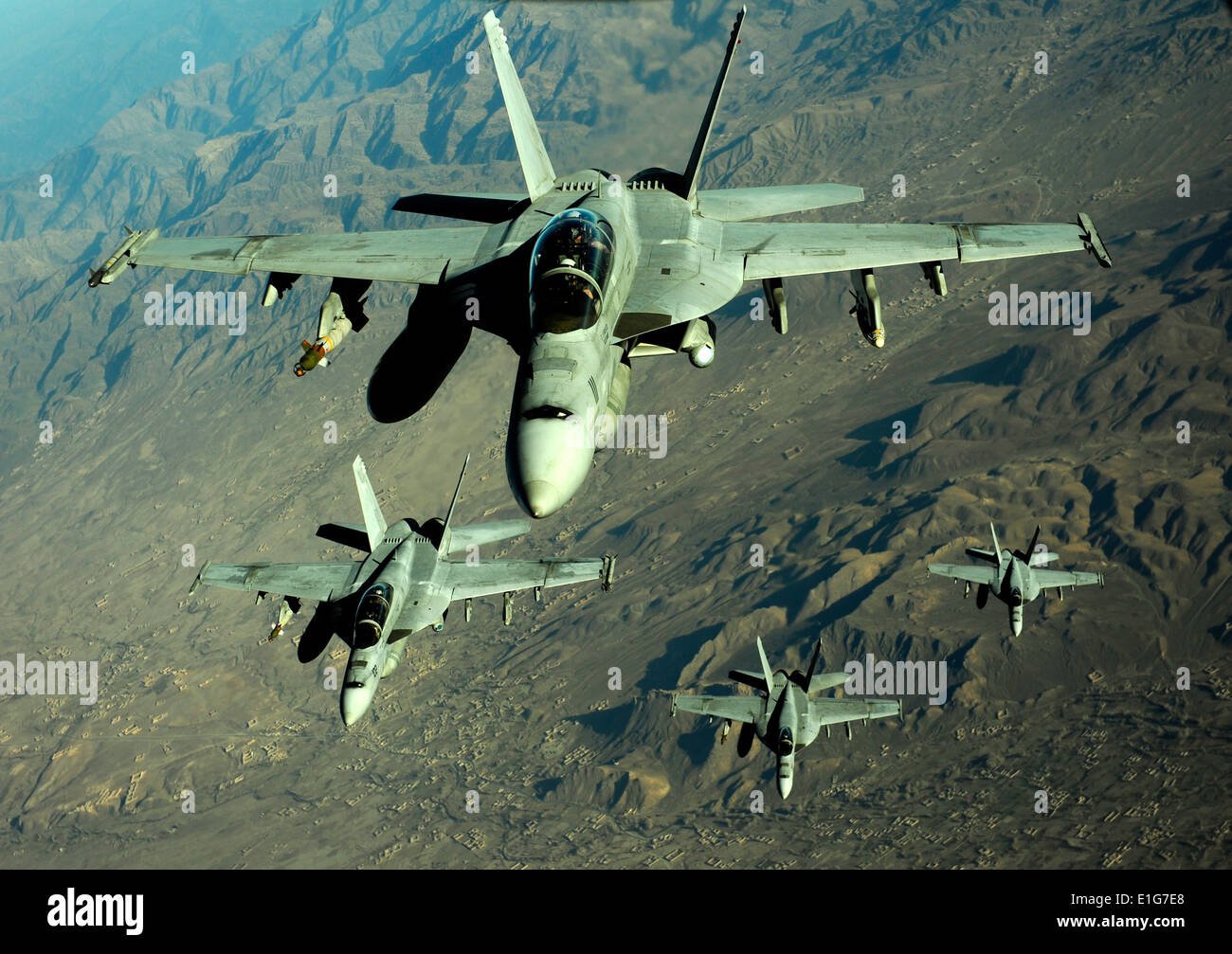 Four U.S. Navy F/A-18 Hornet aircraft fly over mountains in Afghanistan ...