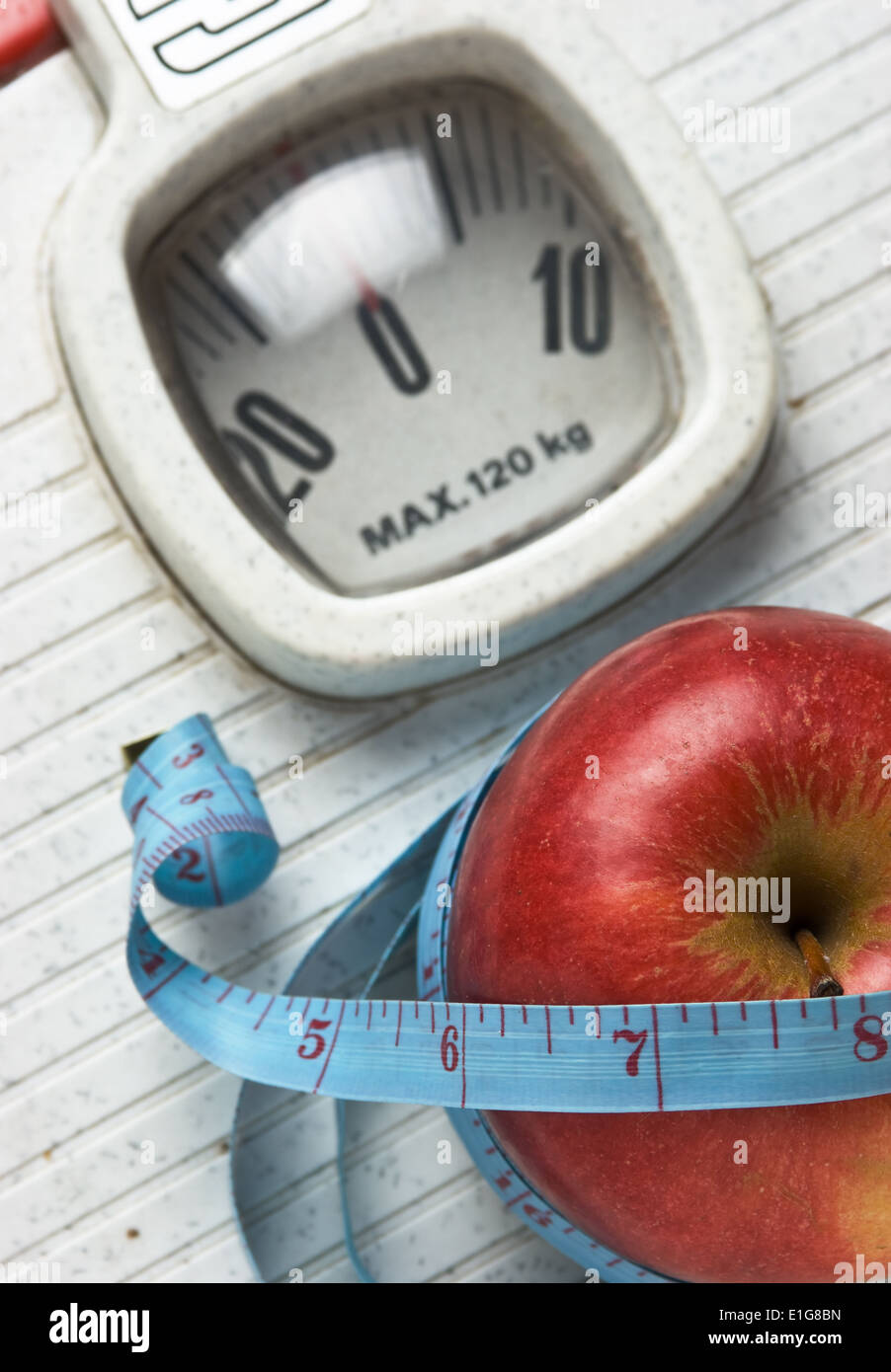 apple and measuring tape on the floor scales isolated on white Stock ...