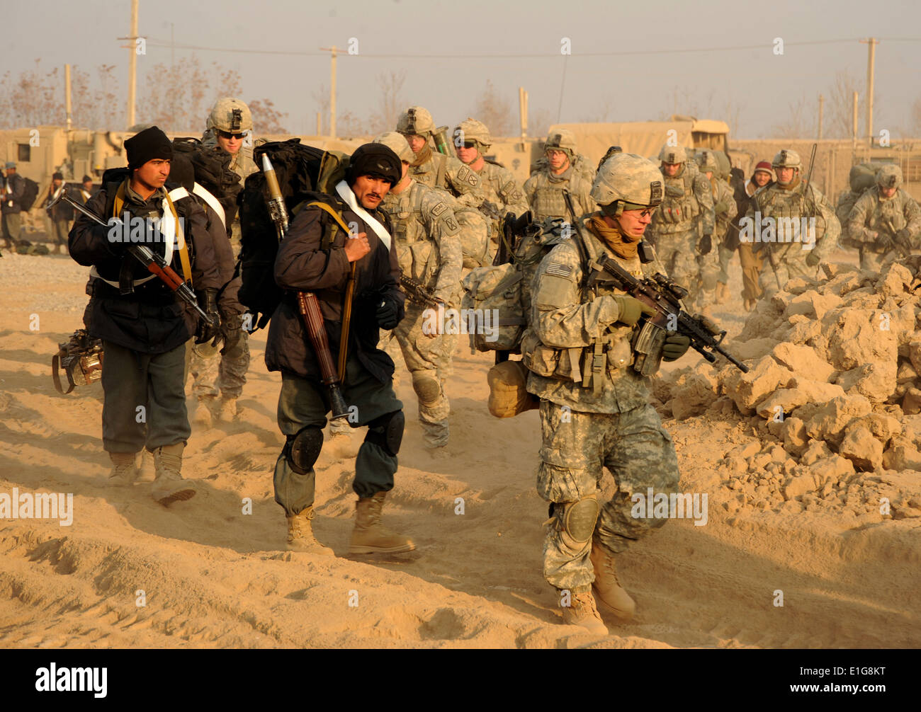 U.S. Army soldiers and Afghan police move out on a foot patrol in the ...