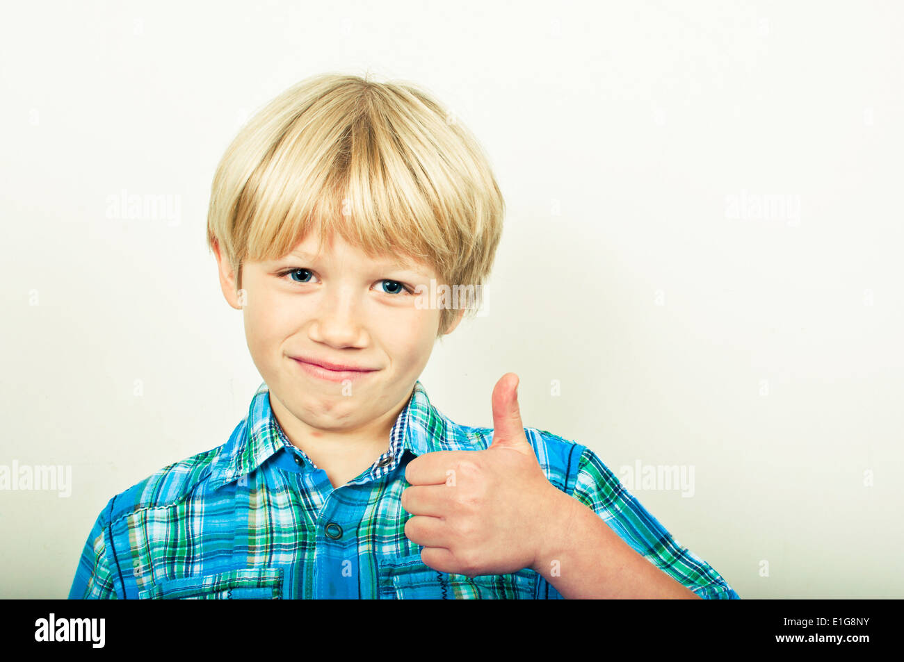Happy child with thumbs up Stock Photo - Alamy