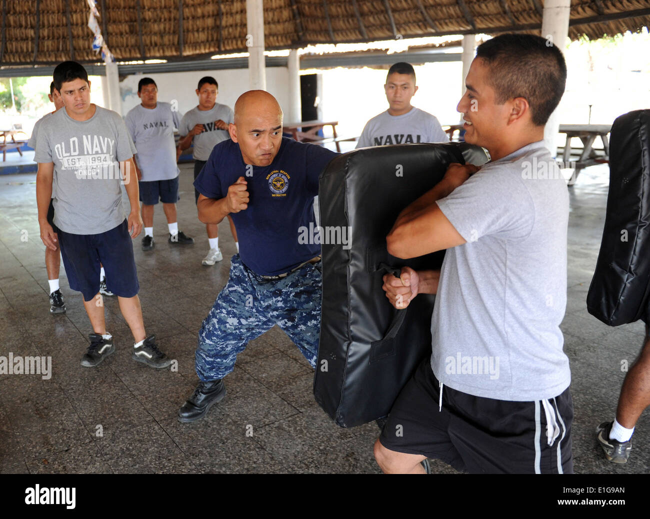 U.S. Navy Chief Master-at-Arms Rodrigo Celones demonstrates proper ...
