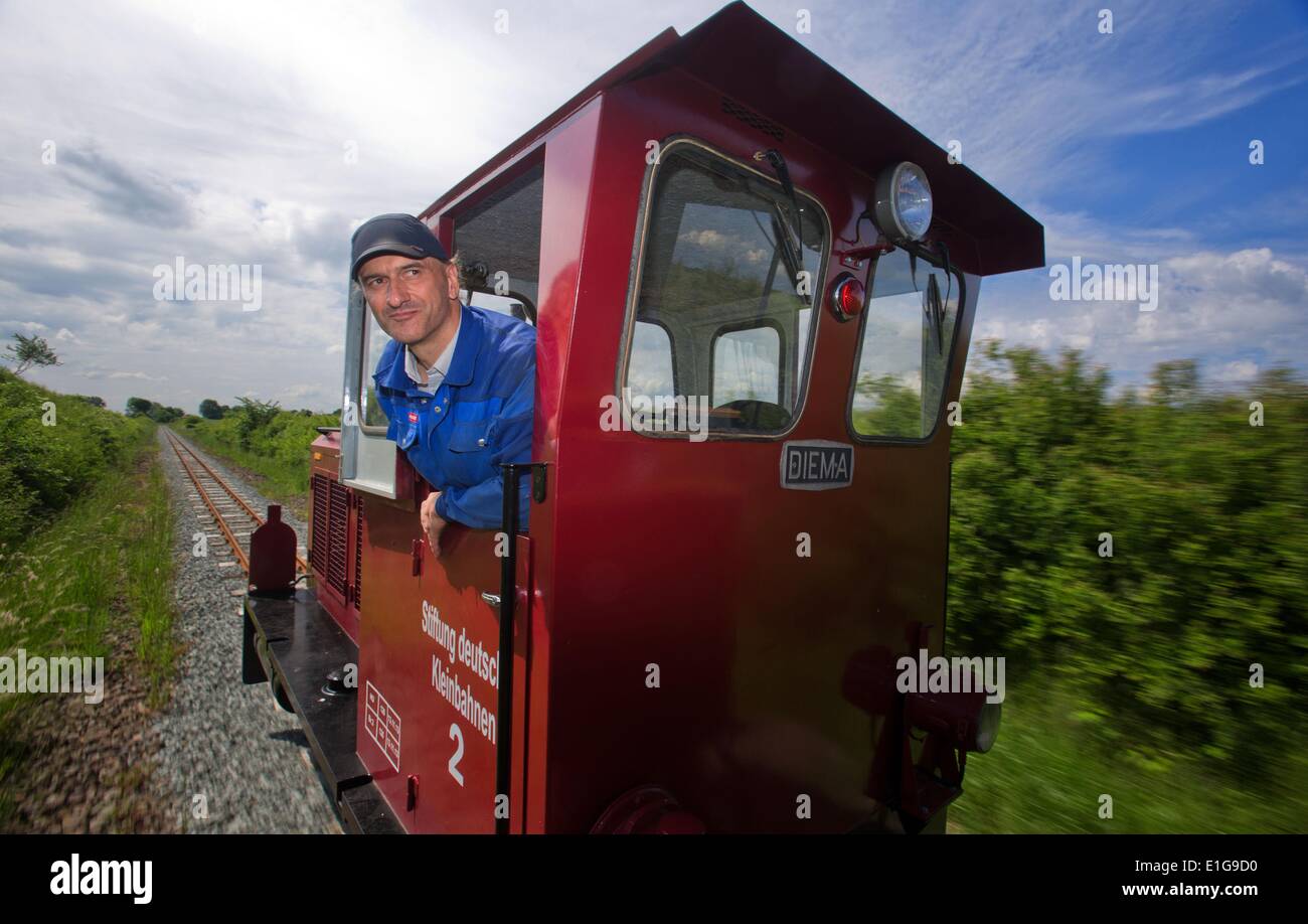 Engineer Thomas Stache looks out from the narrow gage diesel locomotive ...