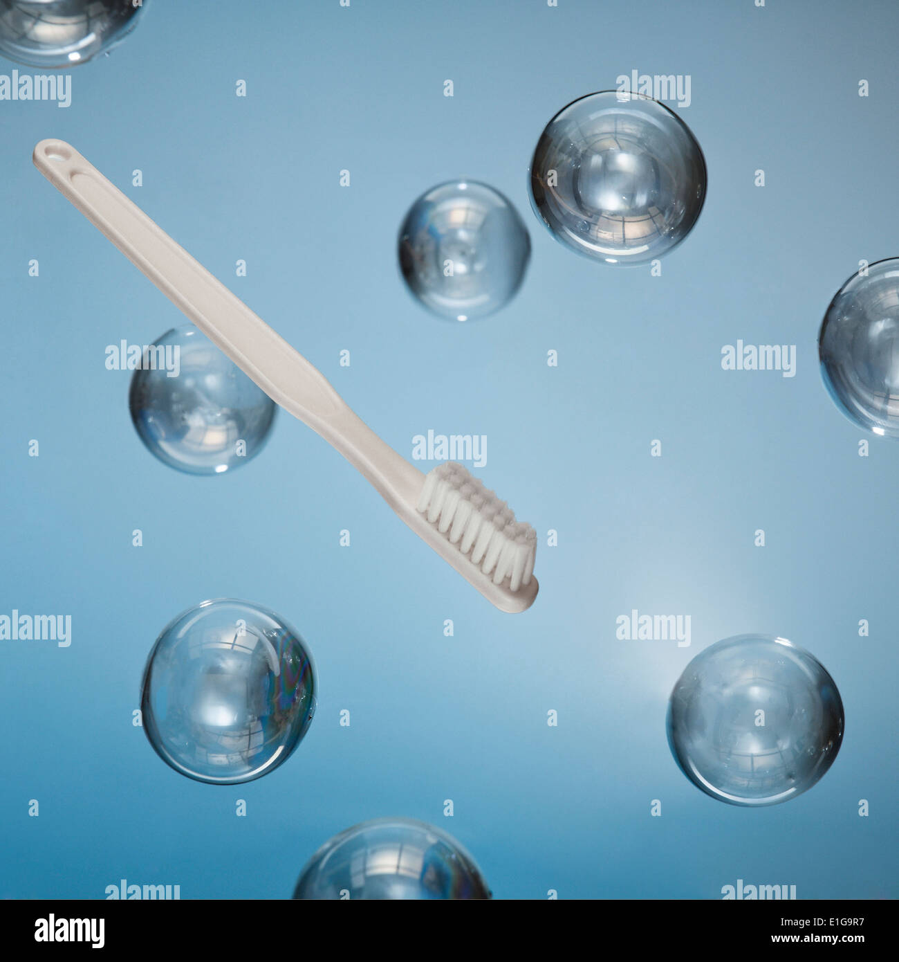 A plain white tooth brush floating with bubbles Stock Photo - Alamy