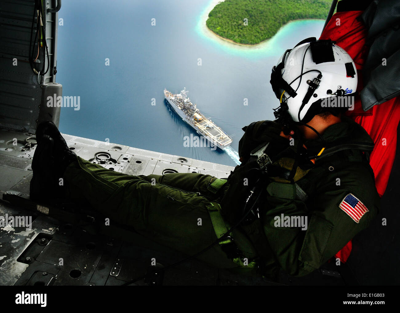U.S. Navy Naval Air Crewman 2nd Class Bowen Derik, right, attached to ...