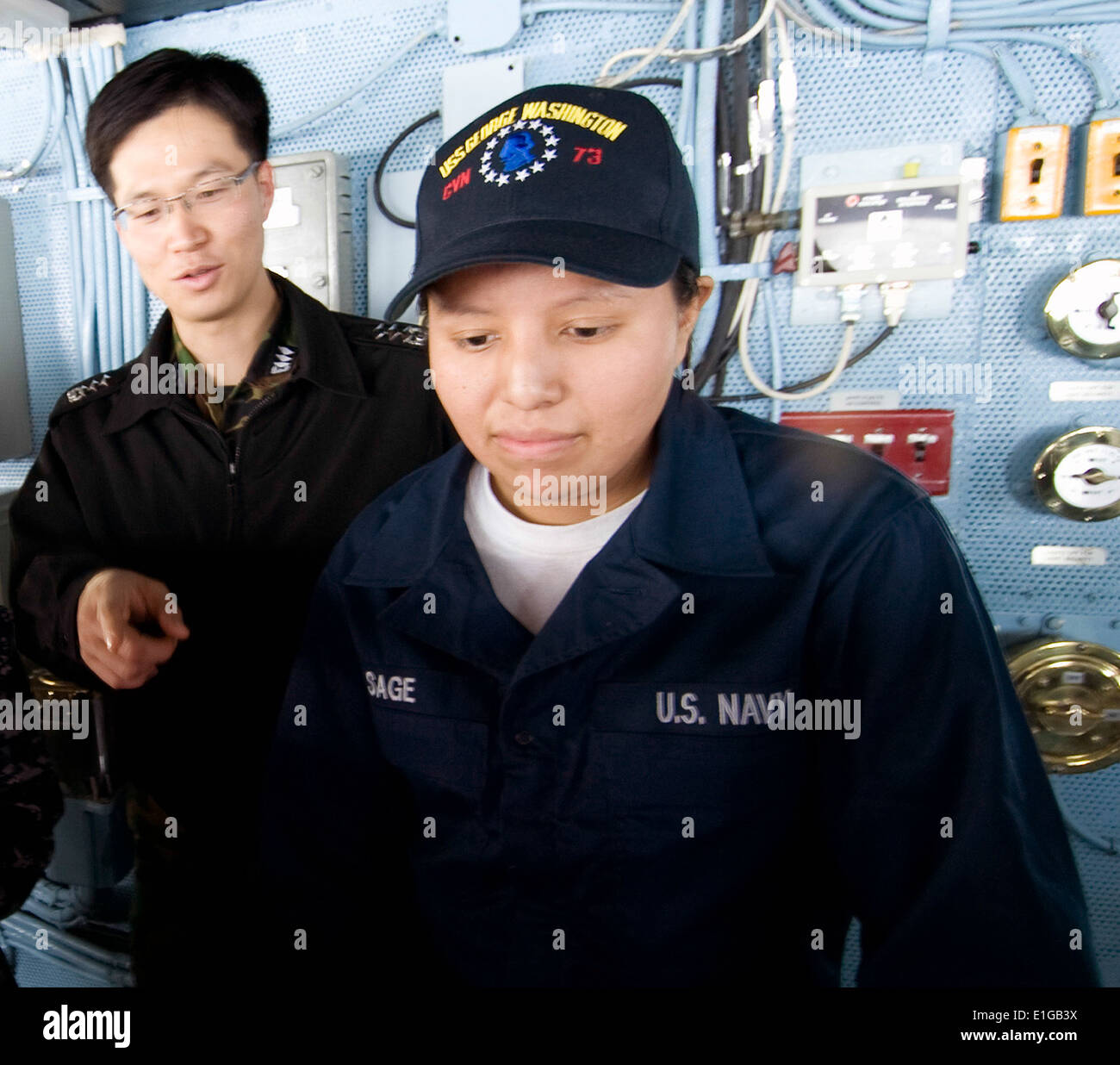 U.S. Navy Boatswain?s Mate Seaman Alissa Sage, right, shows a South ...