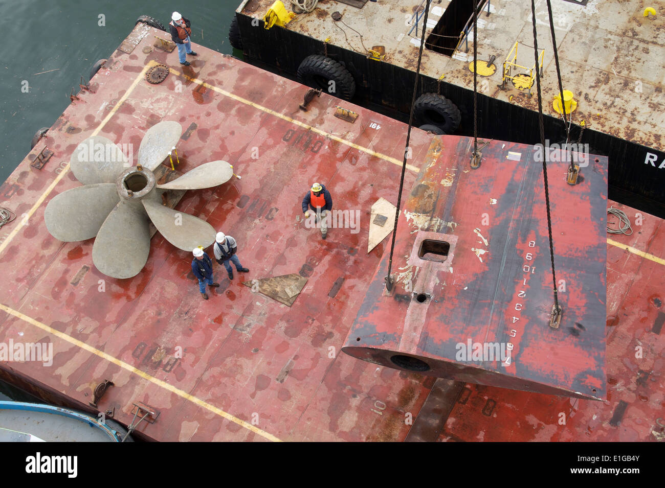 National Steel and Shipbuilding Company shipyard workers use a barge ...