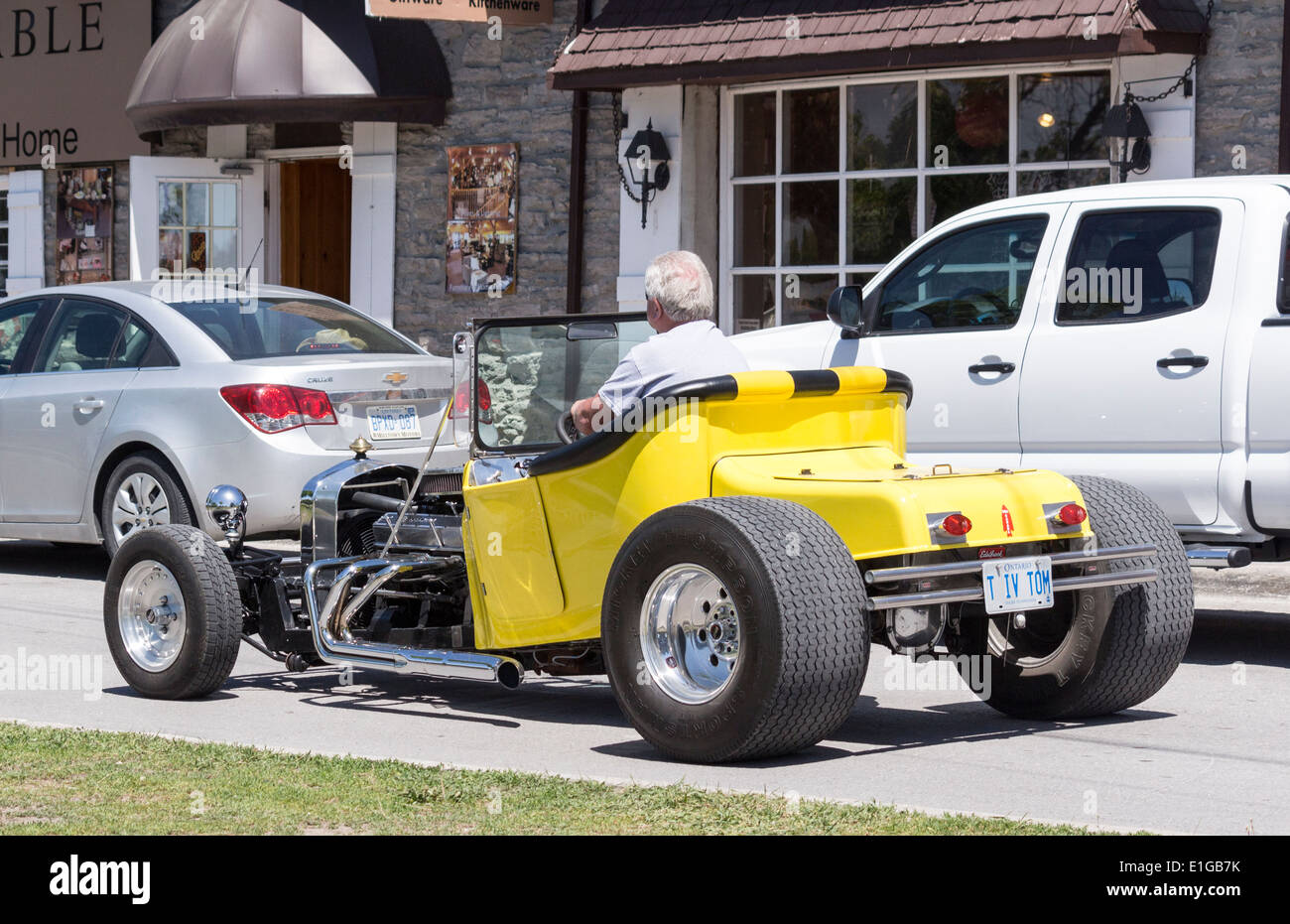 Male senior citizen driving hot rod through Fenelon Falls Ontario Stock ...