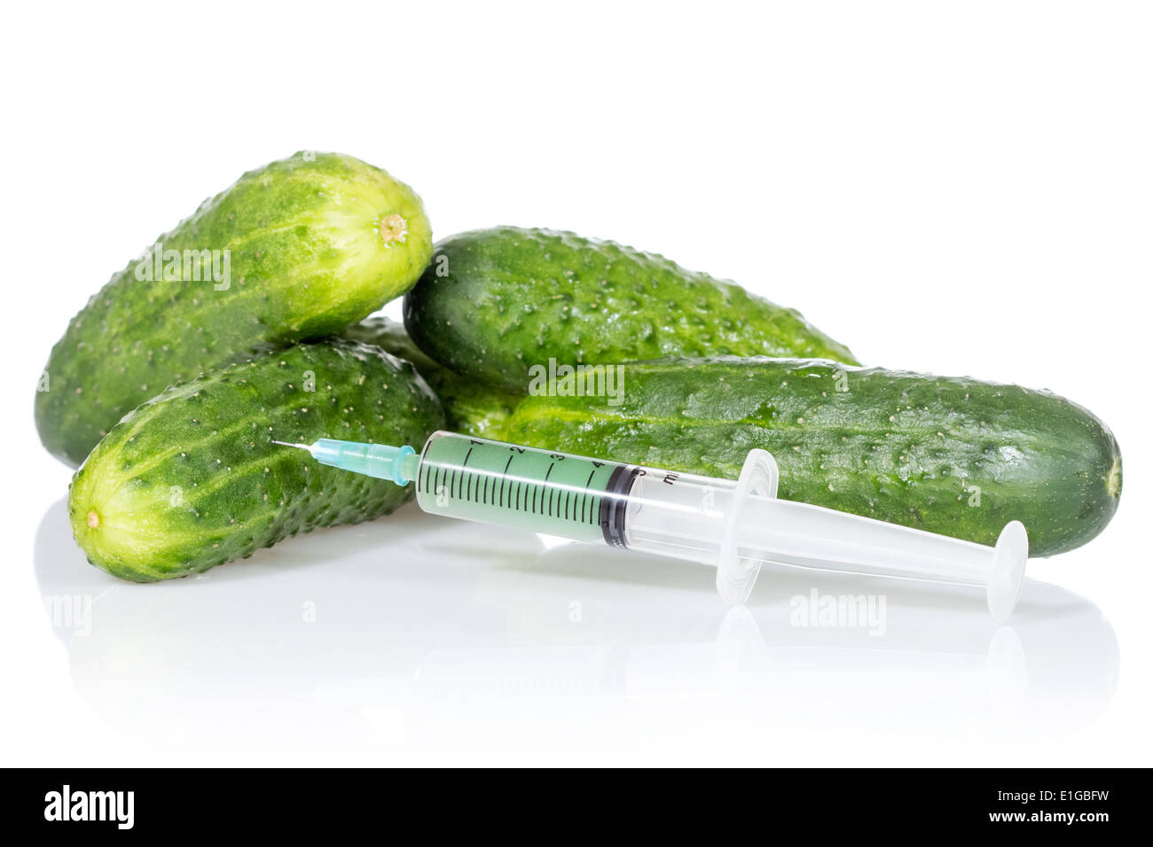 Injection into fresh cucumbers, isolated on white background Stock ...