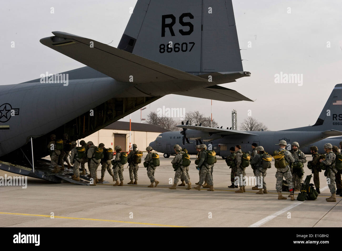 U.S. Soldiers and Airmen and German soldiers load into a C-130J ...
