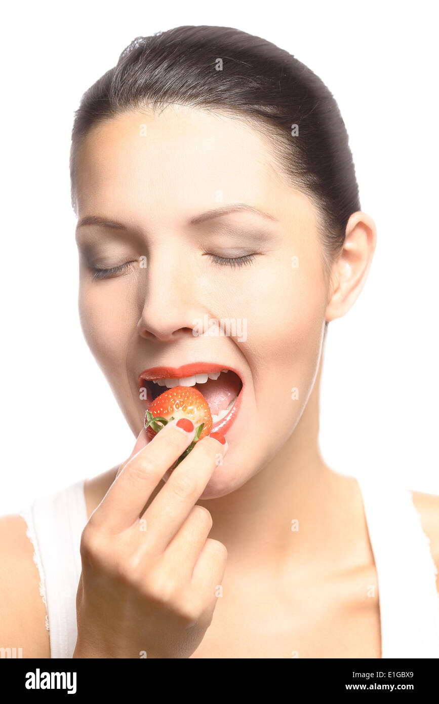 Woman eating a luscious ripe red strawberry Stock Photo - Alamy