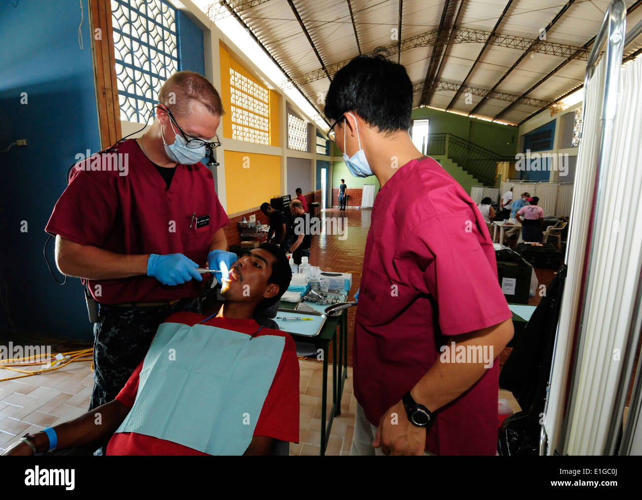 U.S. Navy Lt. Joshua Fair, left, a dentist from the hospital ship USNS ...