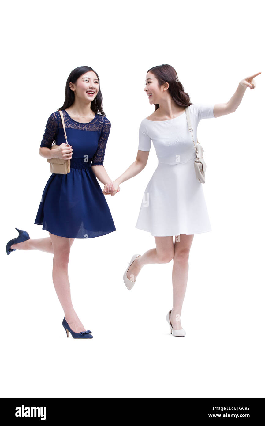 Female friends running hand in hand Stock Photo - Alamy