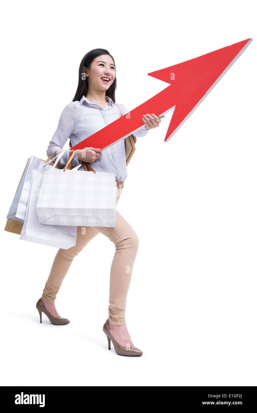 Young woman shopping with red arrow sign in hand Stock Photo - Alamy